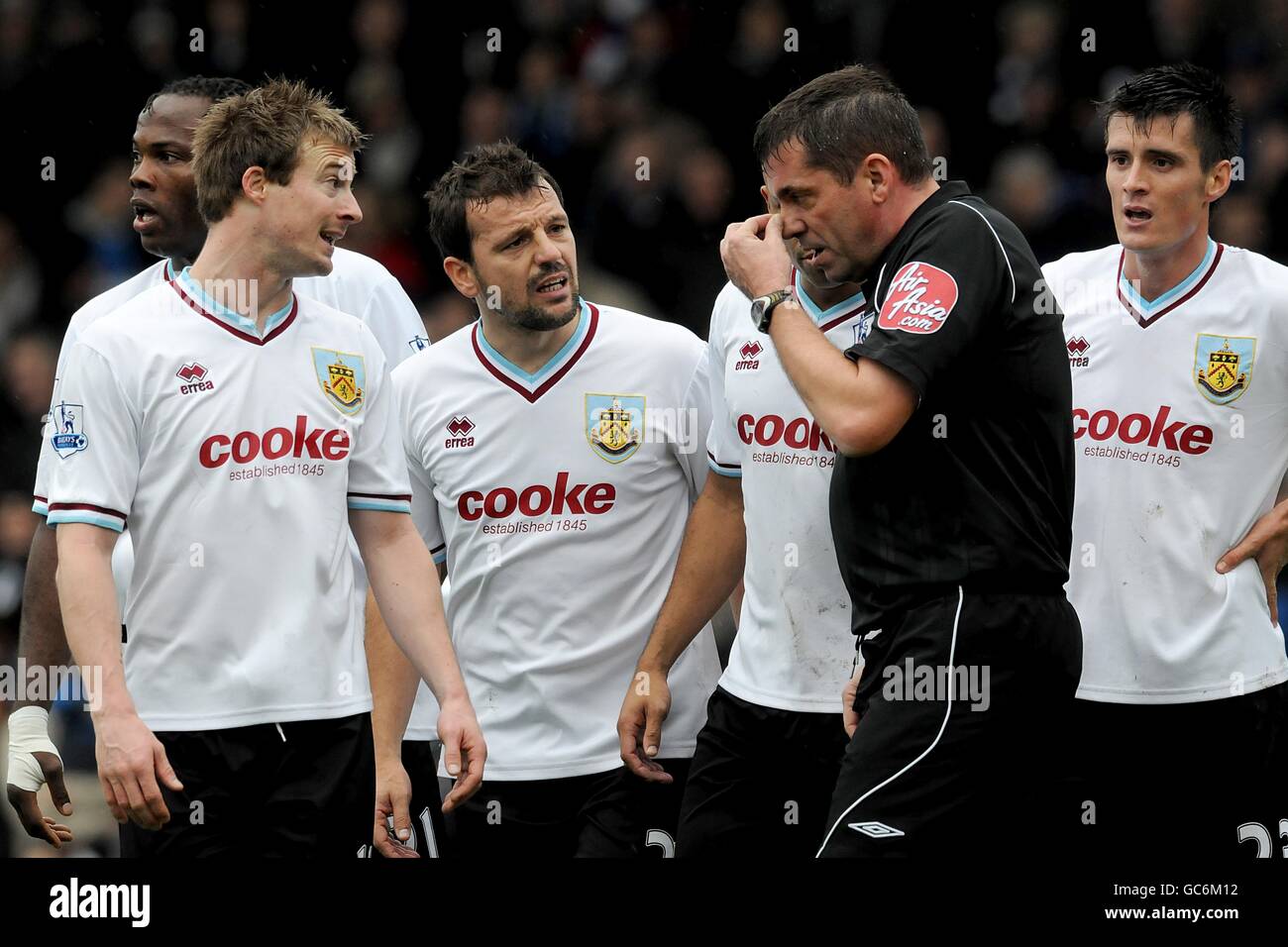Referee Phil Dowd (2nd right) is surrounded by Burnley players for ...