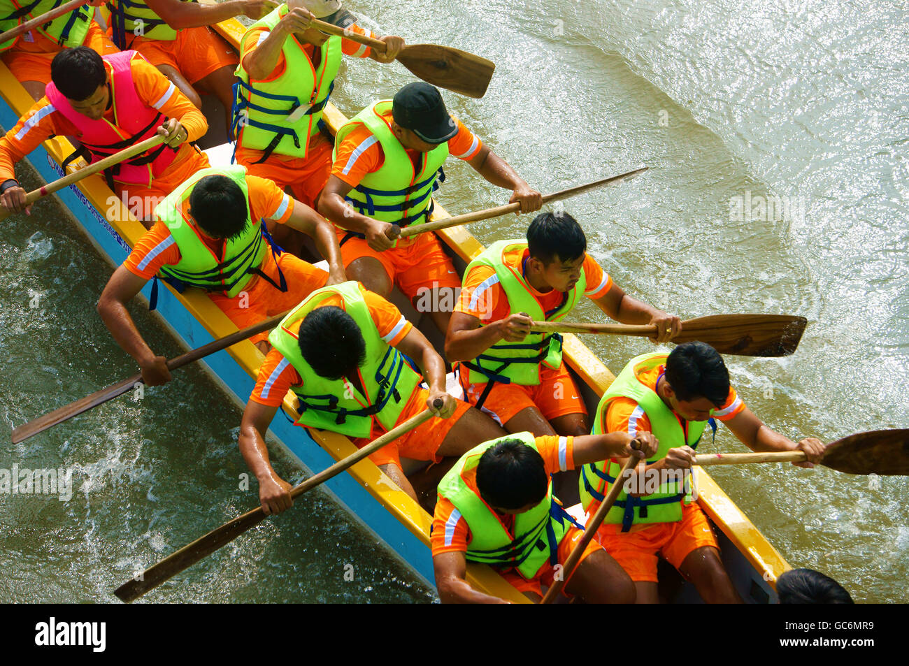 Teamwork of man, rowing dragon boat in racing, try to row with high ...