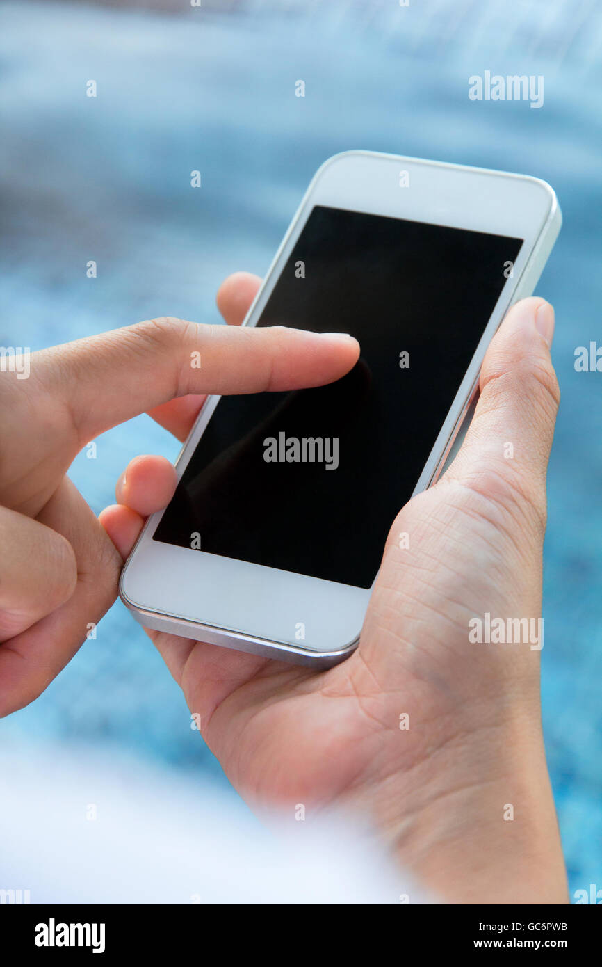Hands of woman pointing at smartphone Stock Photo - Alamy