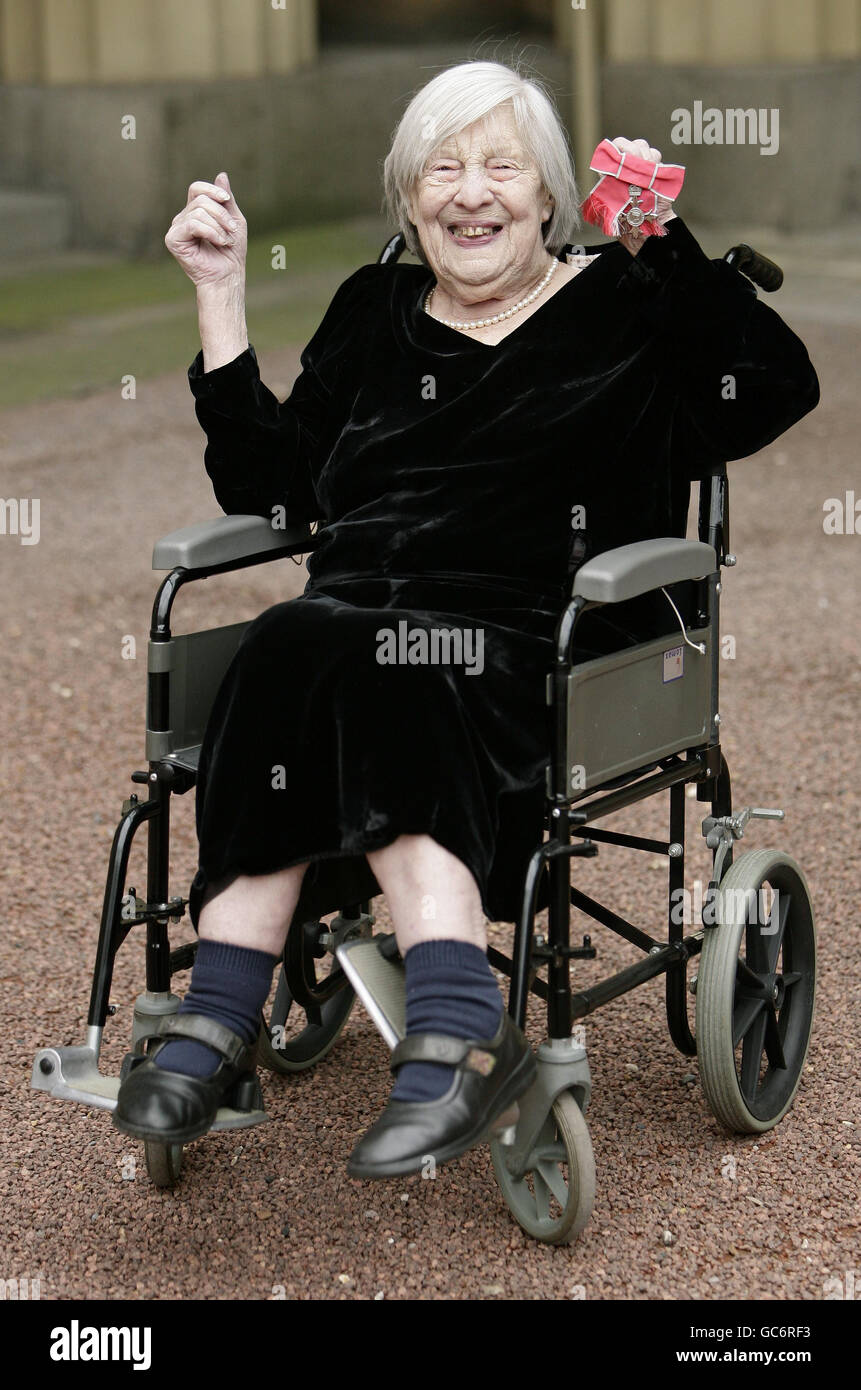 Former EastEnders actress Anna Wing holds her MBE which was awarded to ...