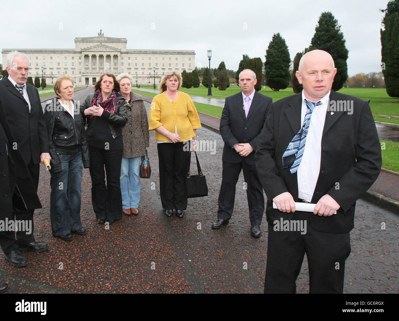 James McGinley, right, son of pensioner Maureen McGinley, arrives with family members at ...