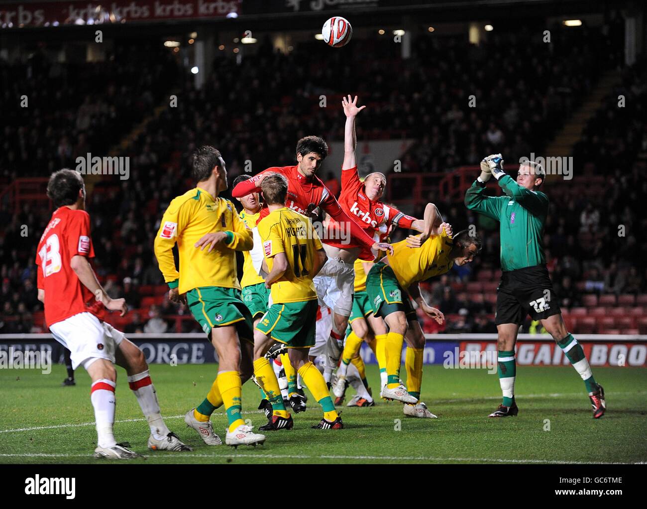 Bristol Rovers goalkeeper Mikkel Andersen (right) comes out to puch a ...