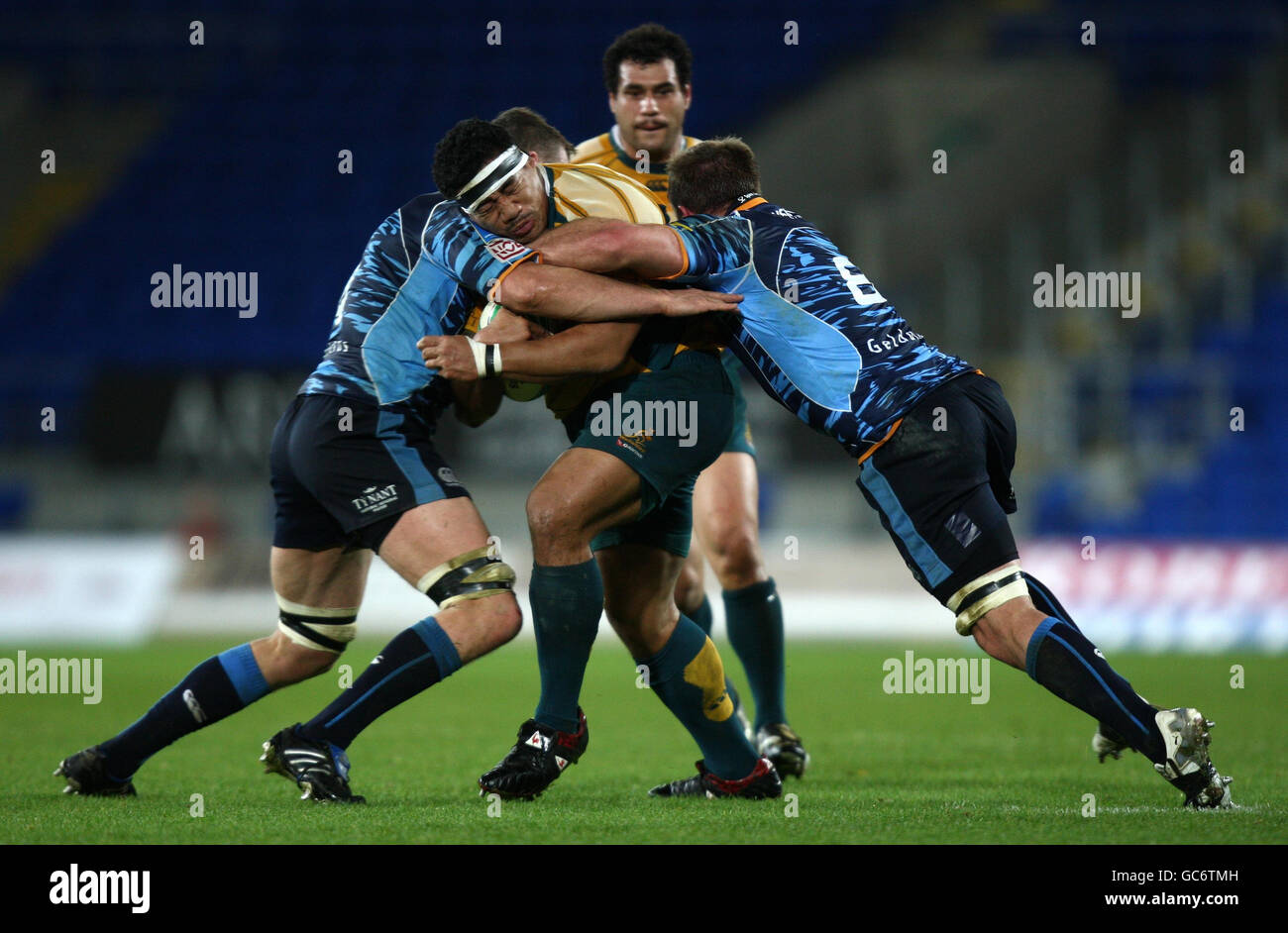 Australia's Salesi Ma'afu (centre) is tackled by Cardiff Blues' Deiniol ...