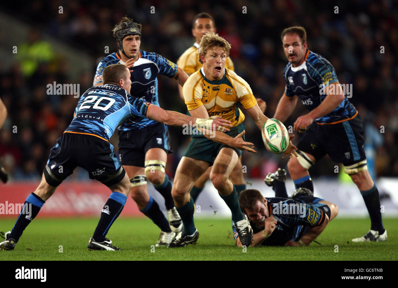 Australia's Lachie Turner (centre) gets his pass away as he is tackled ...