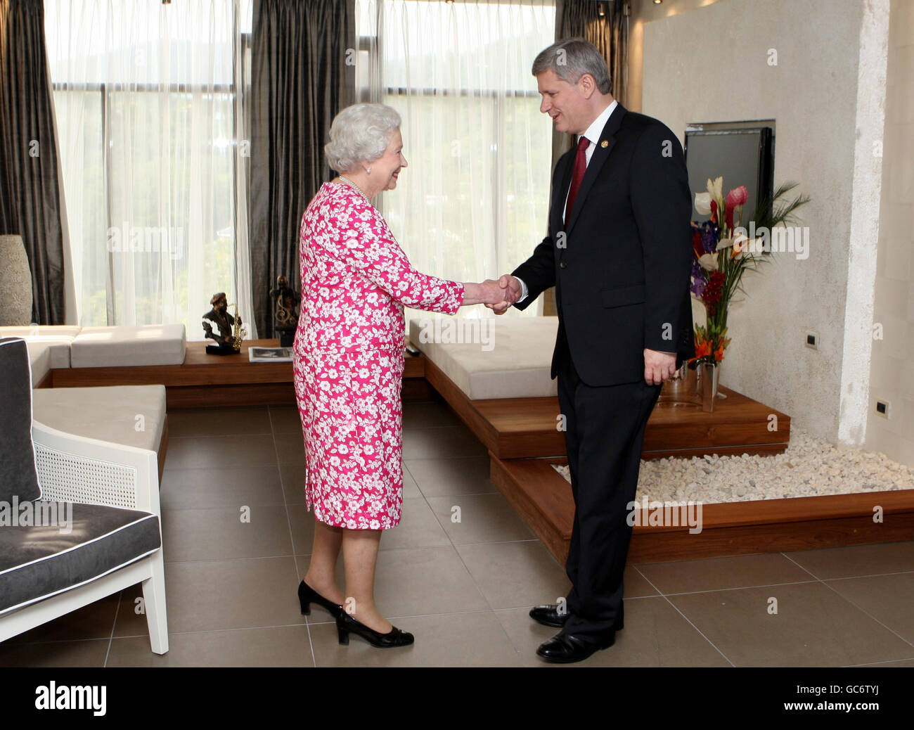 Britain's Queen Elizabeth II shakes hands with Canadian Prime Minister ...