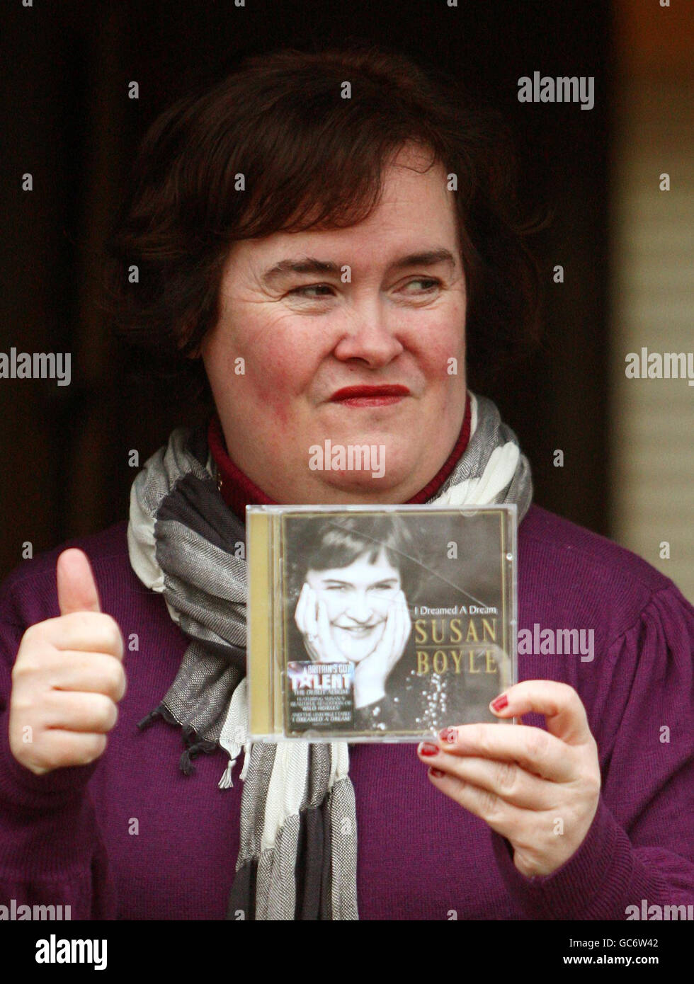 Singer Susan Boyle holds a copy of her album at the front door of her ...