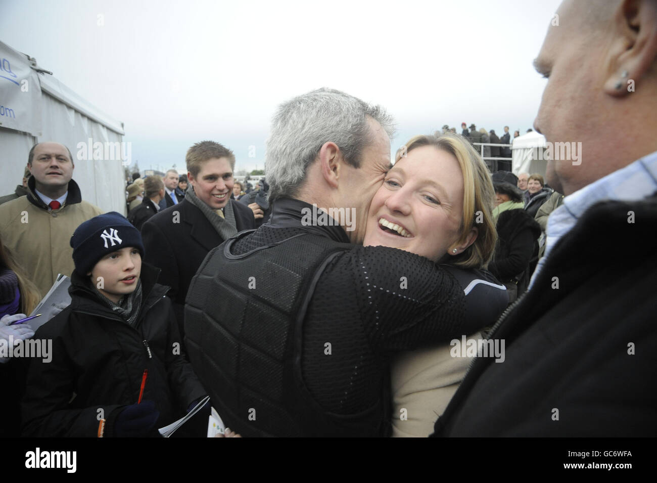 Wife of winning jockey Ruby Walsh gives him a hug after his victory on ...