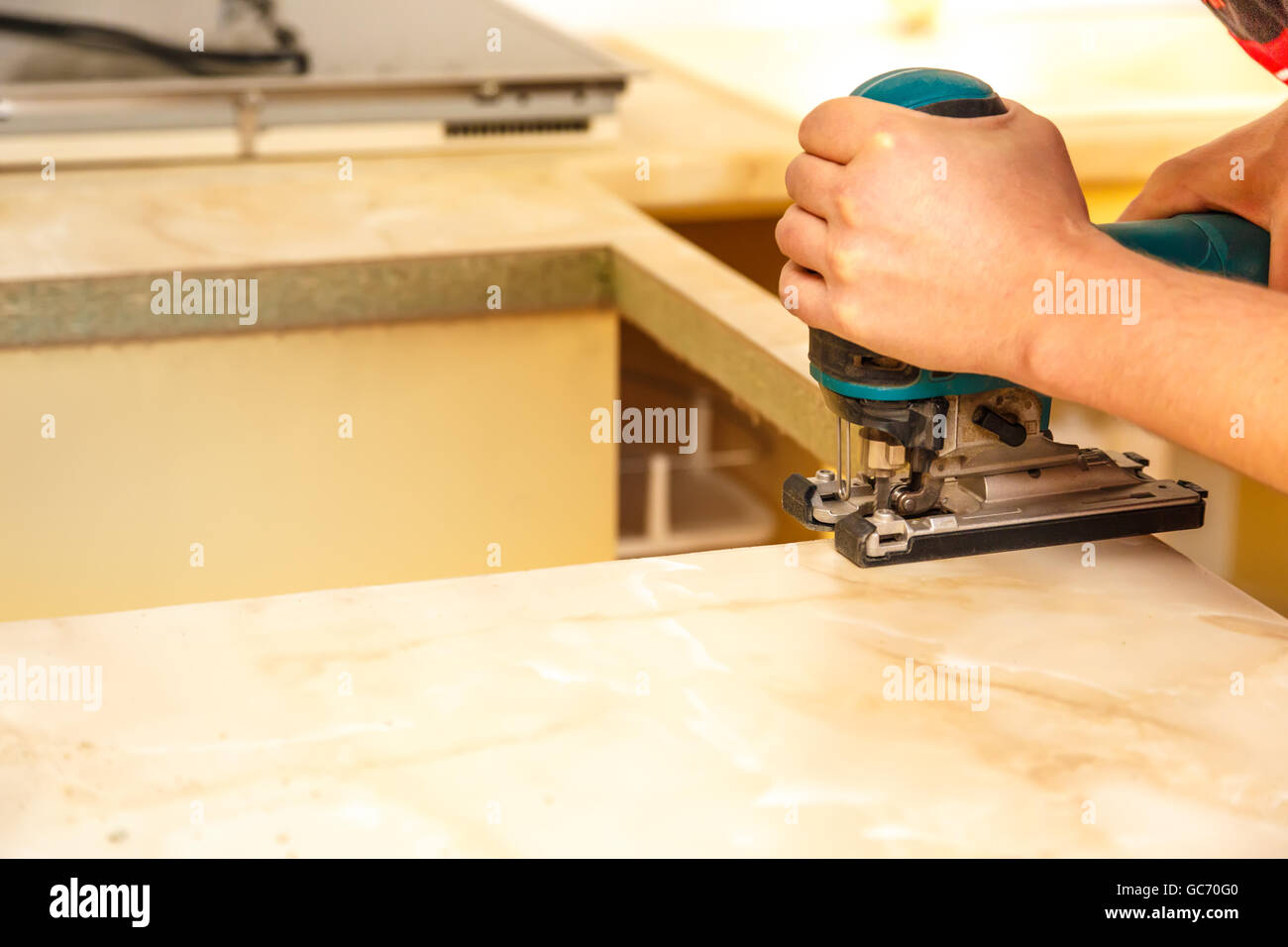 Installing new induction hob in modern kitchen Stock Photo - Alamy