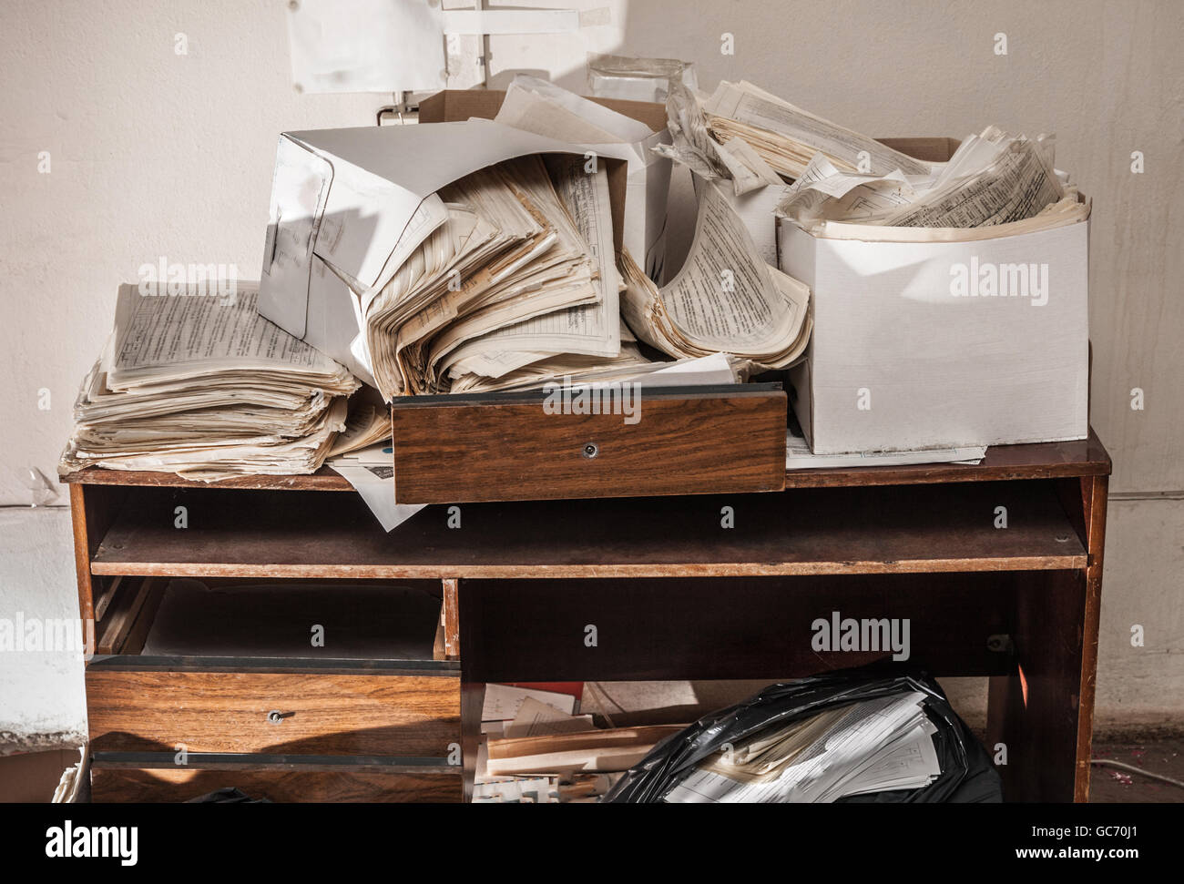 Messy workplace with stack of the paper Stock Photo - Alamy
