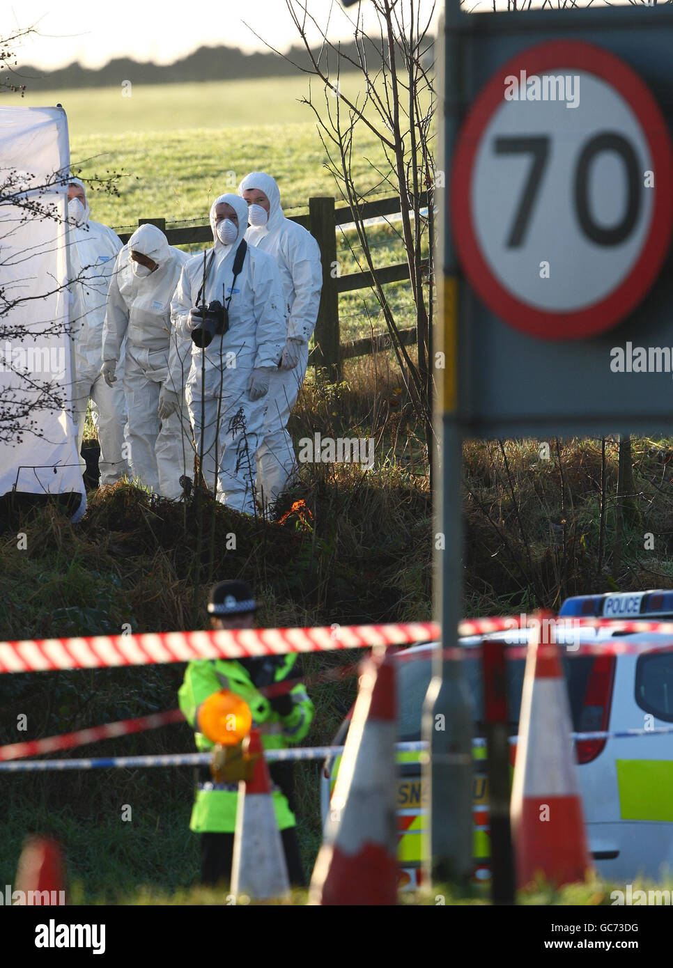A team of police forensics investigate the scene where a body has been ...
