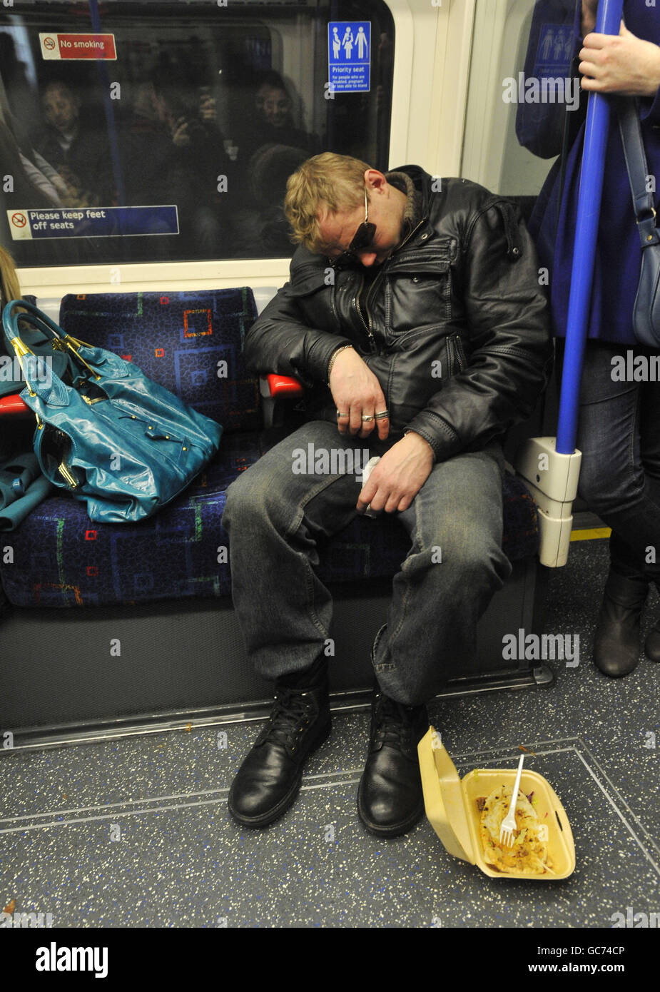 A drunken man asleep on tube central london hi-res stock photography ...