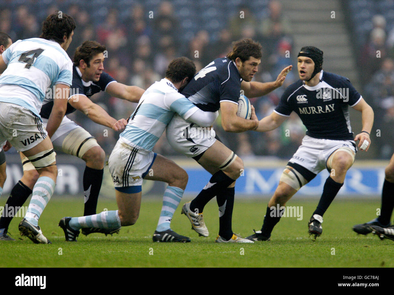 Scotlands sean lamont centre right breaks through an argentinian tackle ...