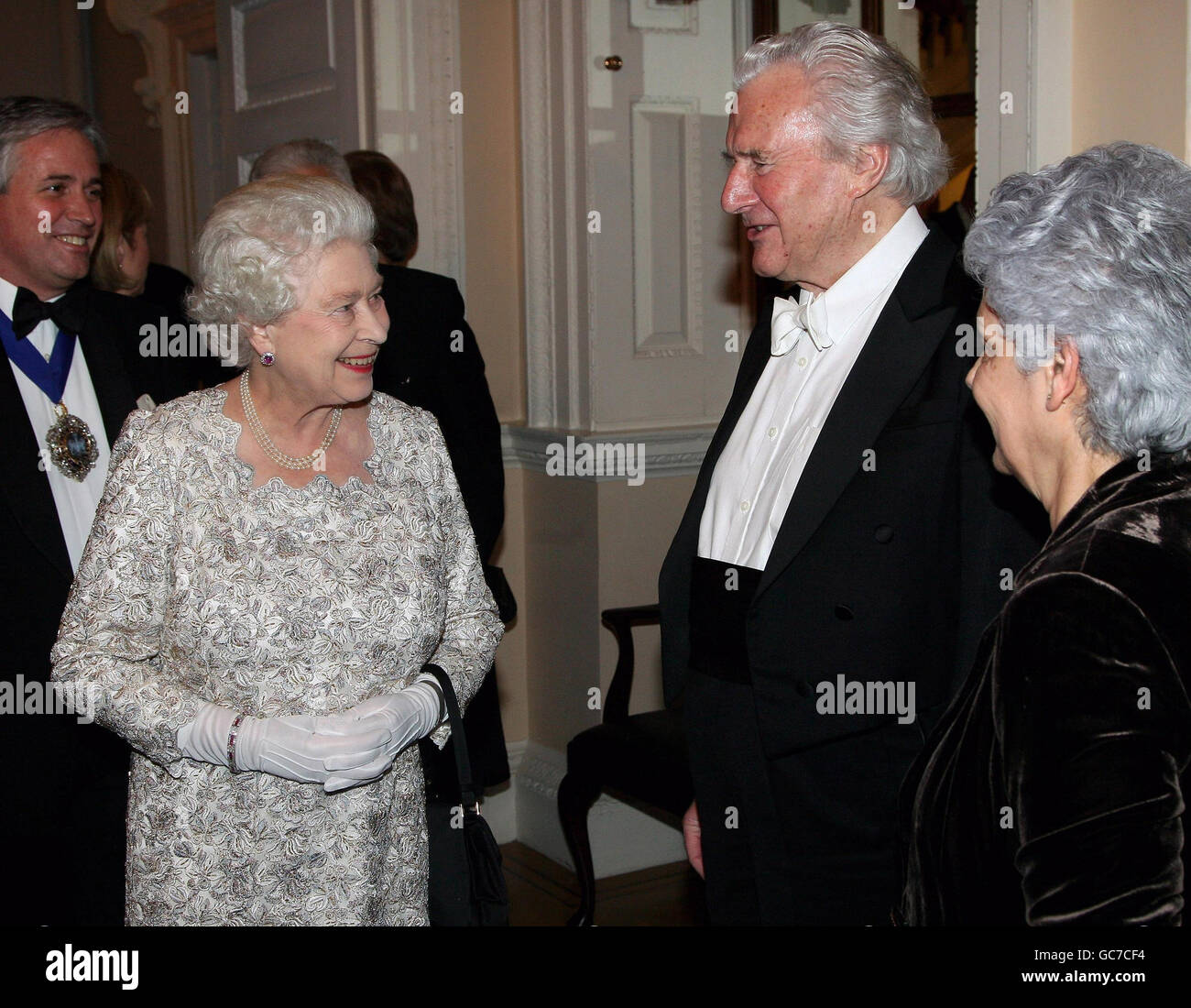 Queen Elizabeth II is greeted by conductor Sir Colin Davis as she ...