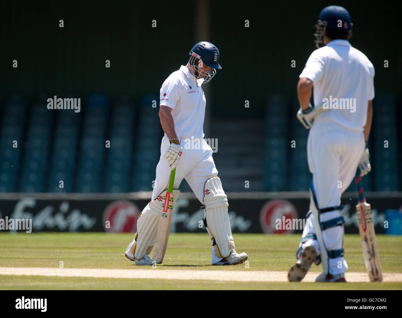 England captain Andrew Strauss (left) leaves the field after being ...