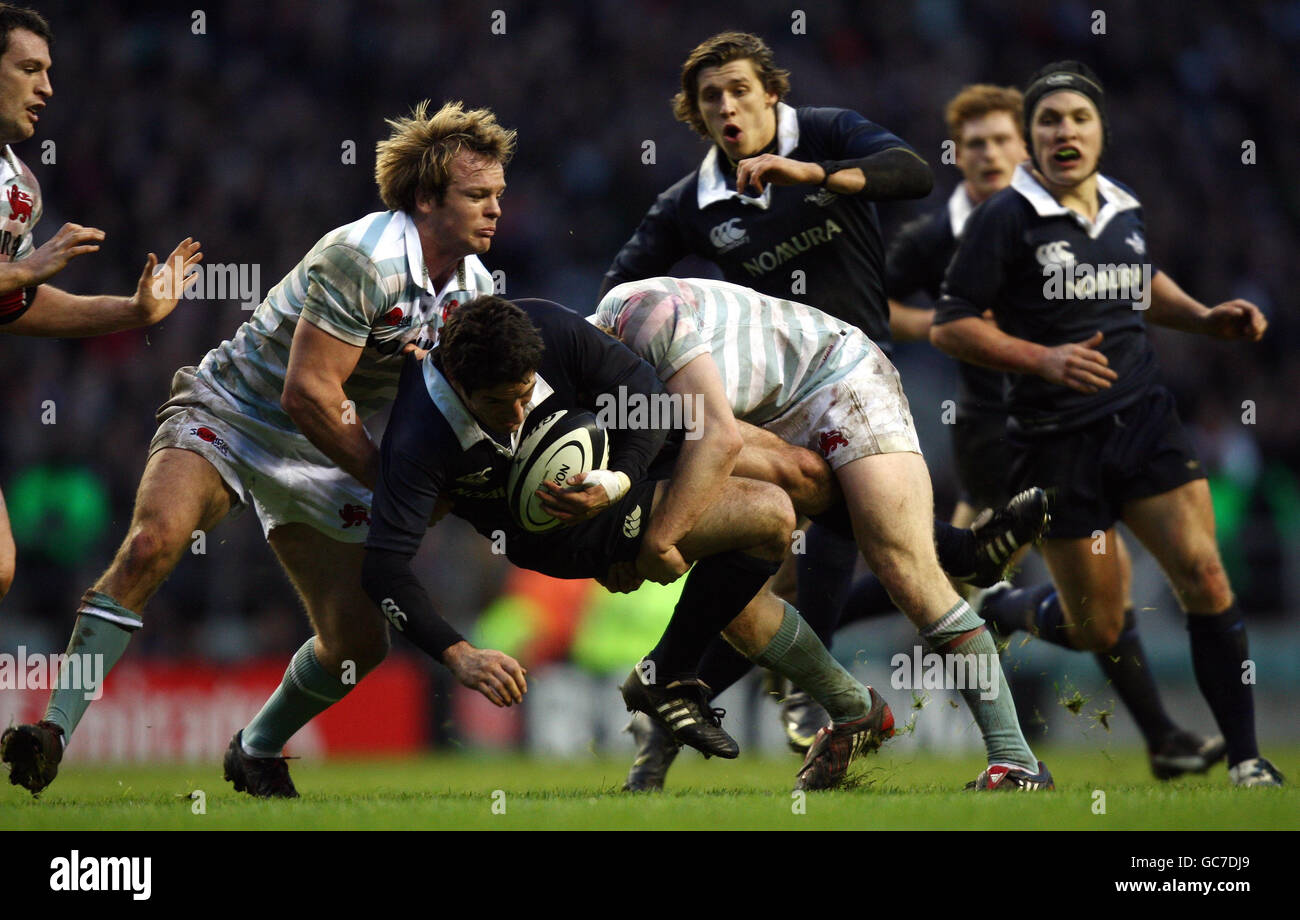 Oxford's Chris Mahony (centre) is tackled by Cambridge's Fred Burden ...