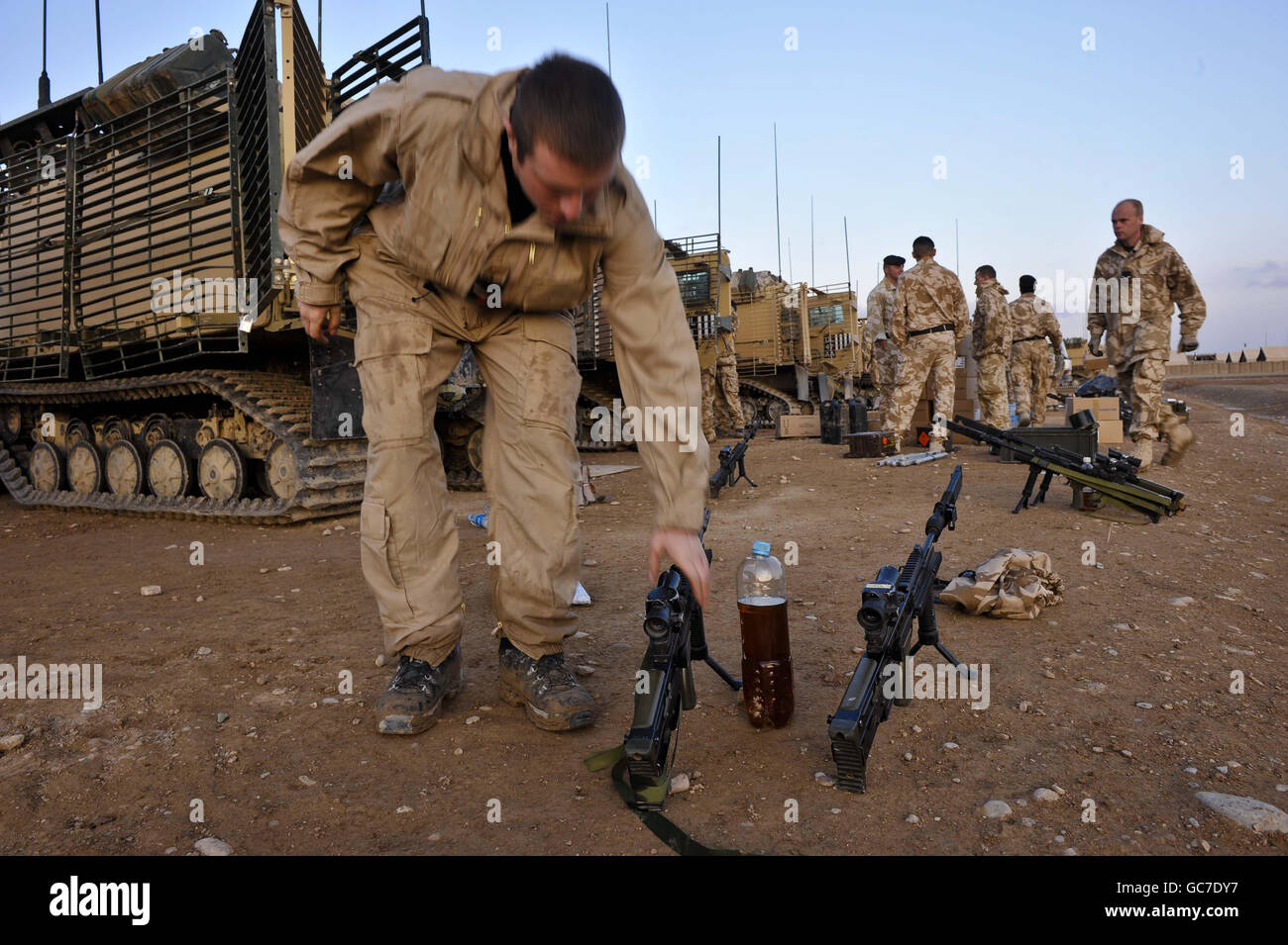 A soldier from D Squadron 1st Royal Tank Regiment lifts a machine gun ...