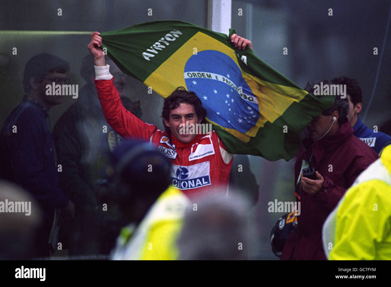 Brazilian Ayrton Senna flying the Brazilian flag as he works his way ...
