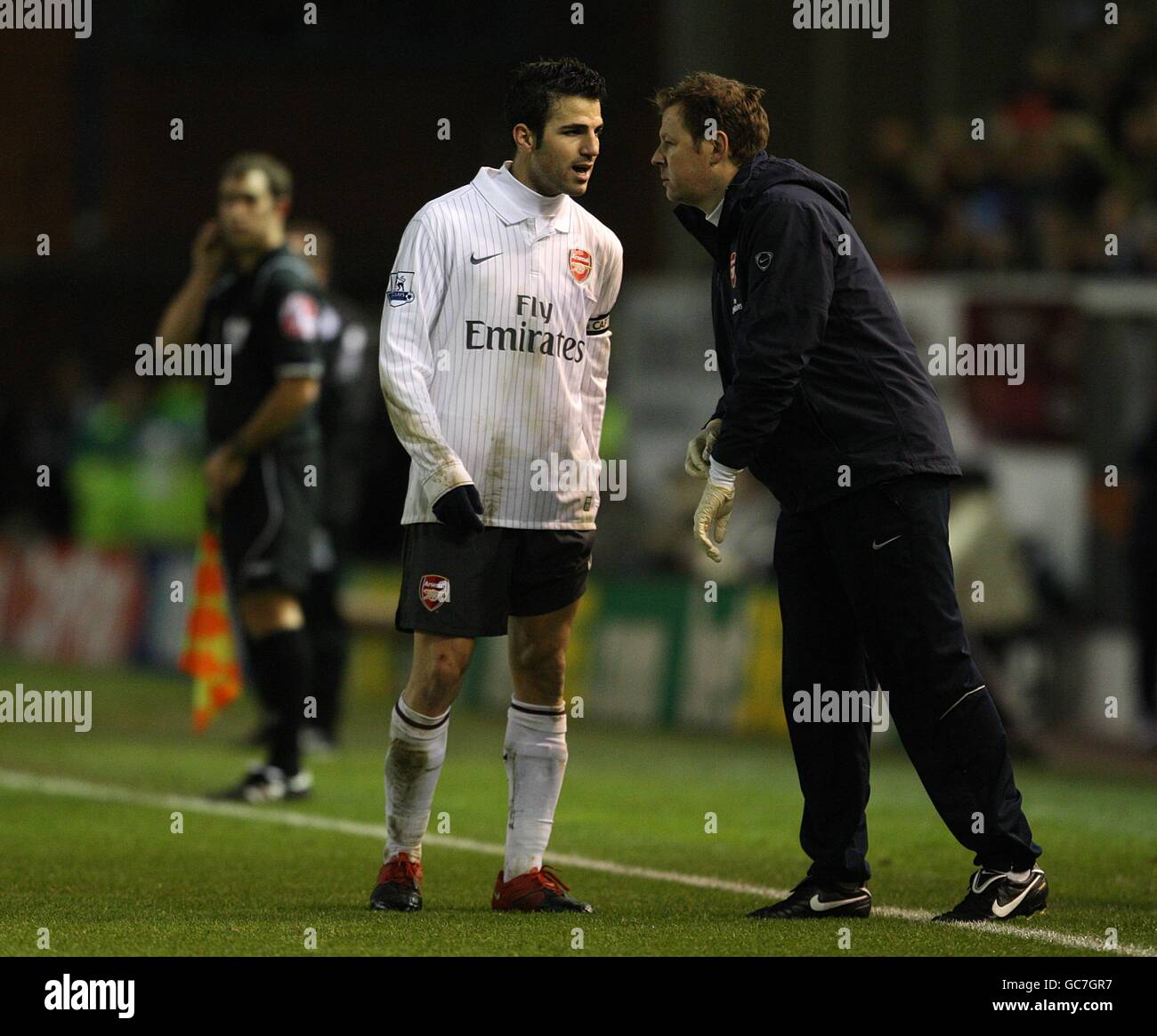 Arsenal's Francesc Fabregas (centre) chats with the team Physio after ...