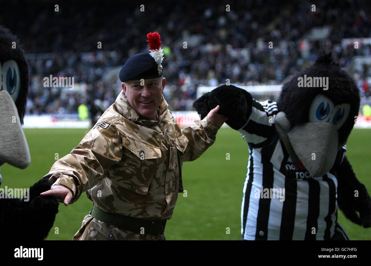 Soldiers on the pitch prior to kick off with Newcastle United mascot ...