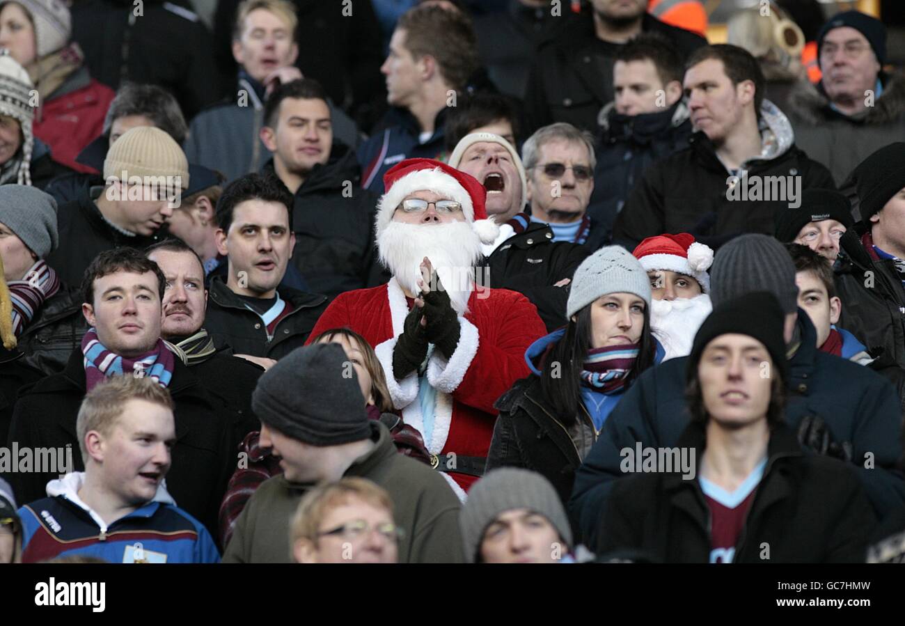 A fan dressed as Santa Claus watches the action from the stands Stock ...