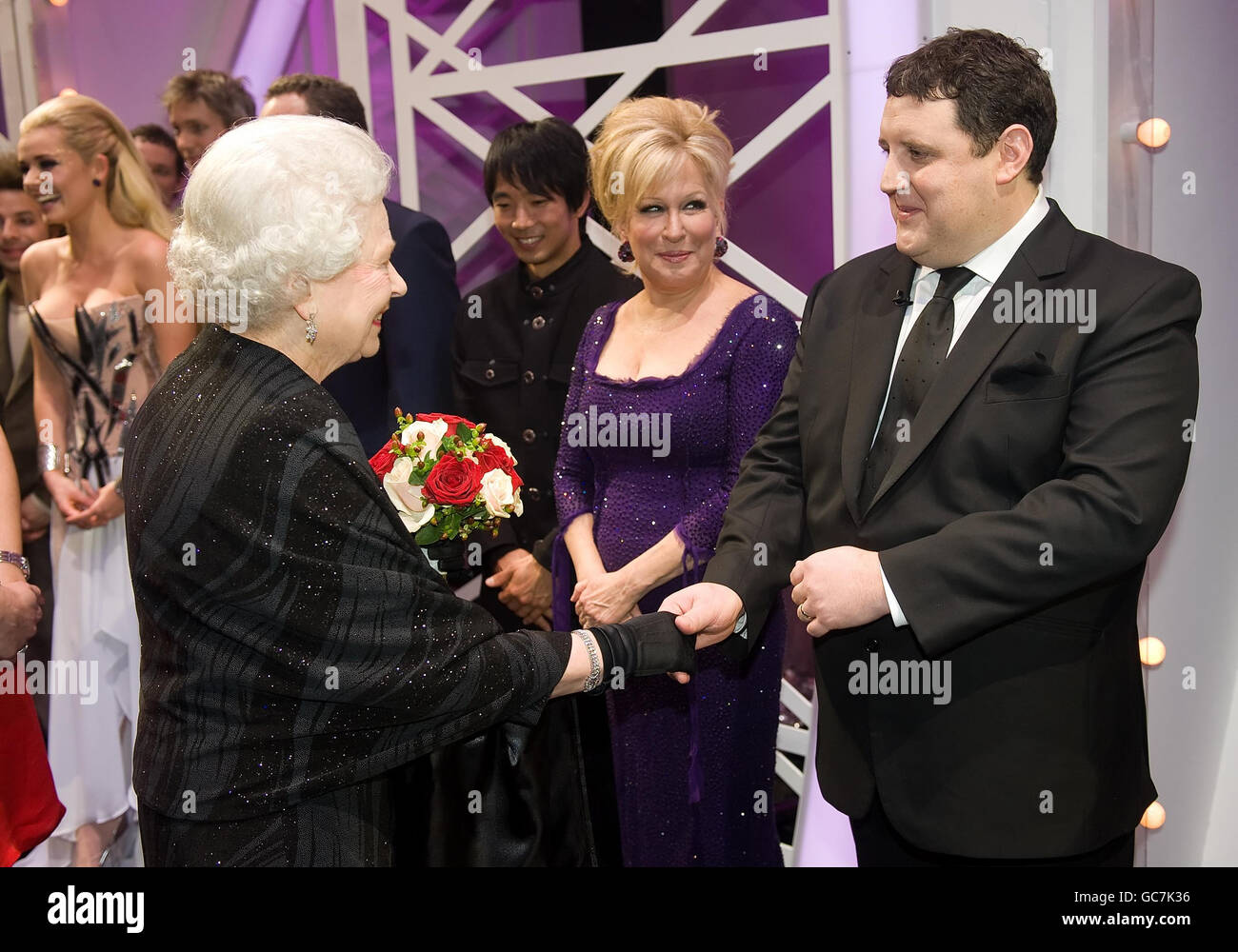 Britain's Queen Elizabeth II (L) meets British comedian Peter Kay (R ...