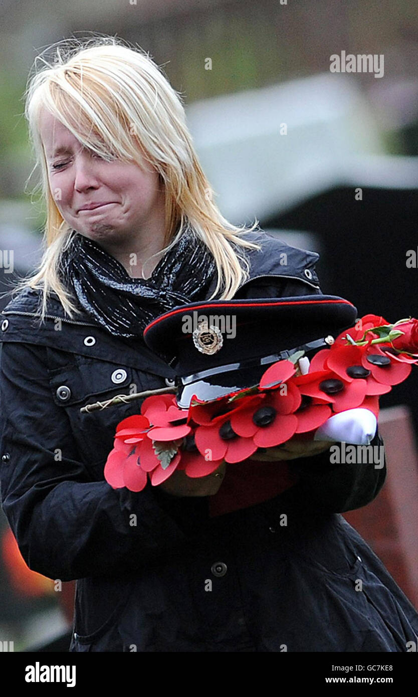 Family friend Jessica Lambe holds the cap and medals of Corporal Loren ...