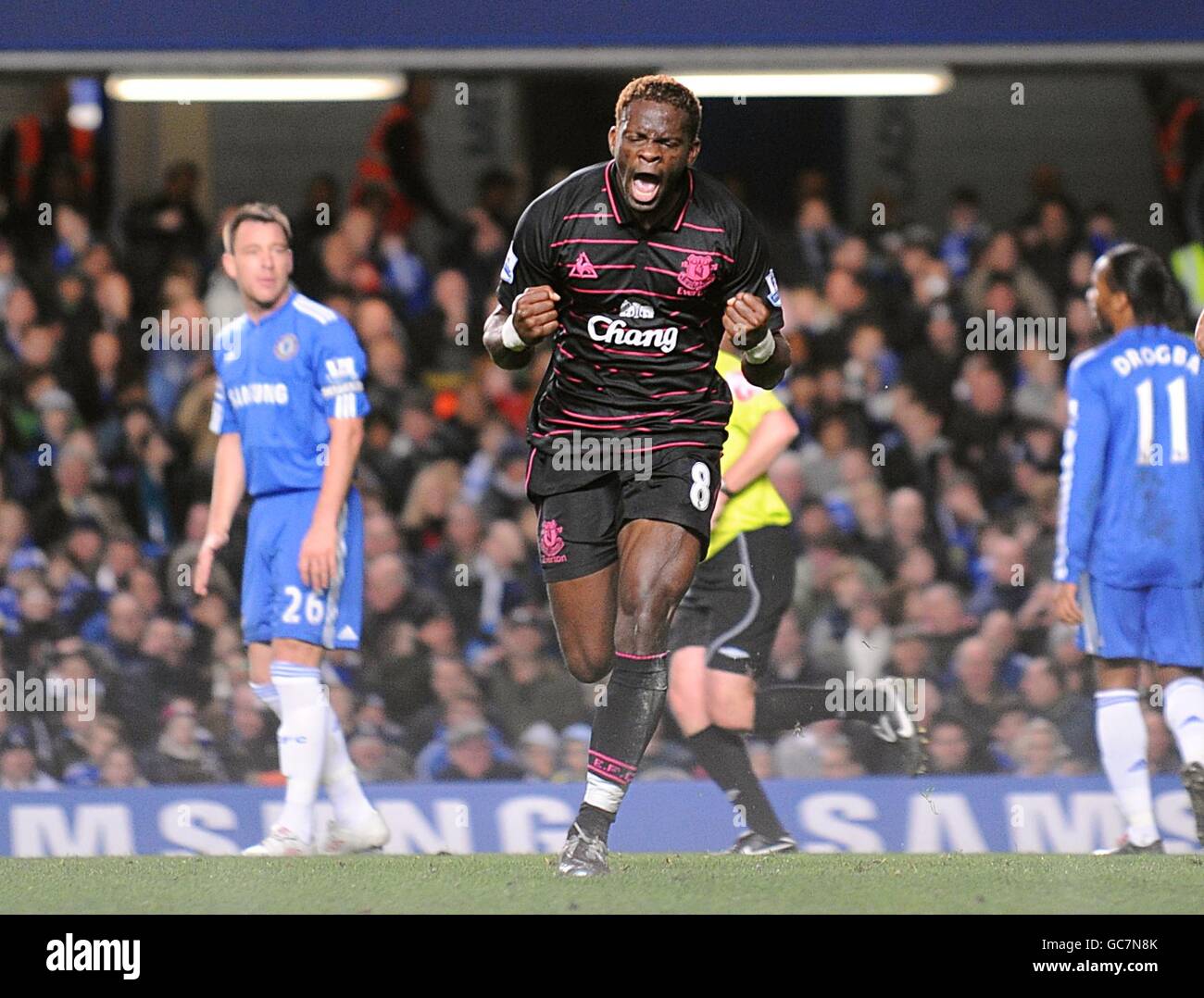 Everton's Louis Saha (centre) celebrates after scoring their third goal ...