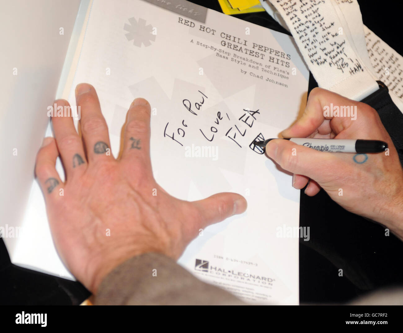 Red Hot Chili Peppers' bassist Flea sign autographs for fans at the ...
