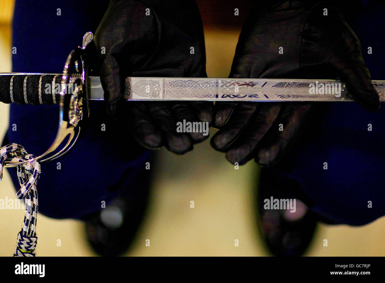 A member of the Air Corps holds his ceremonial commissioning sword in ...