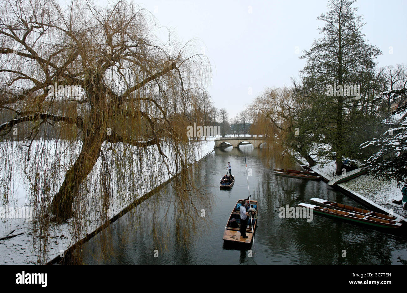Punters enjoy the winter scenery along the River Cam in Cambridge as ...