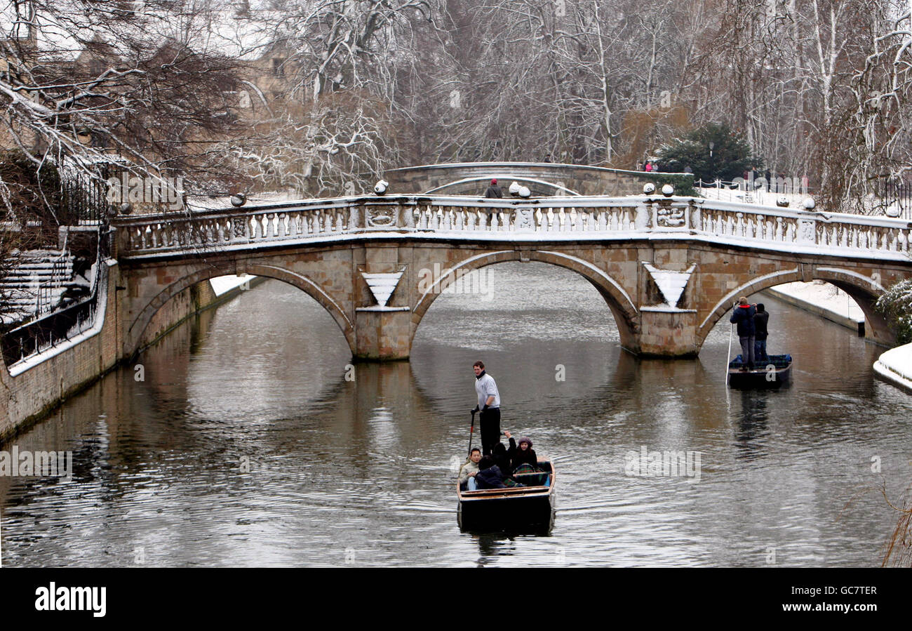 Punters enjoy the winter scenery along the River Cam in Cambridge as ...