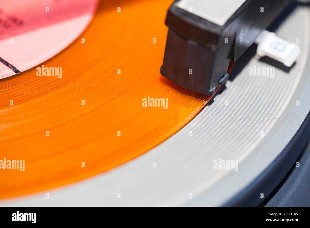 headshell of turntable on orange vinyl record close up Stock Photo - Alamy