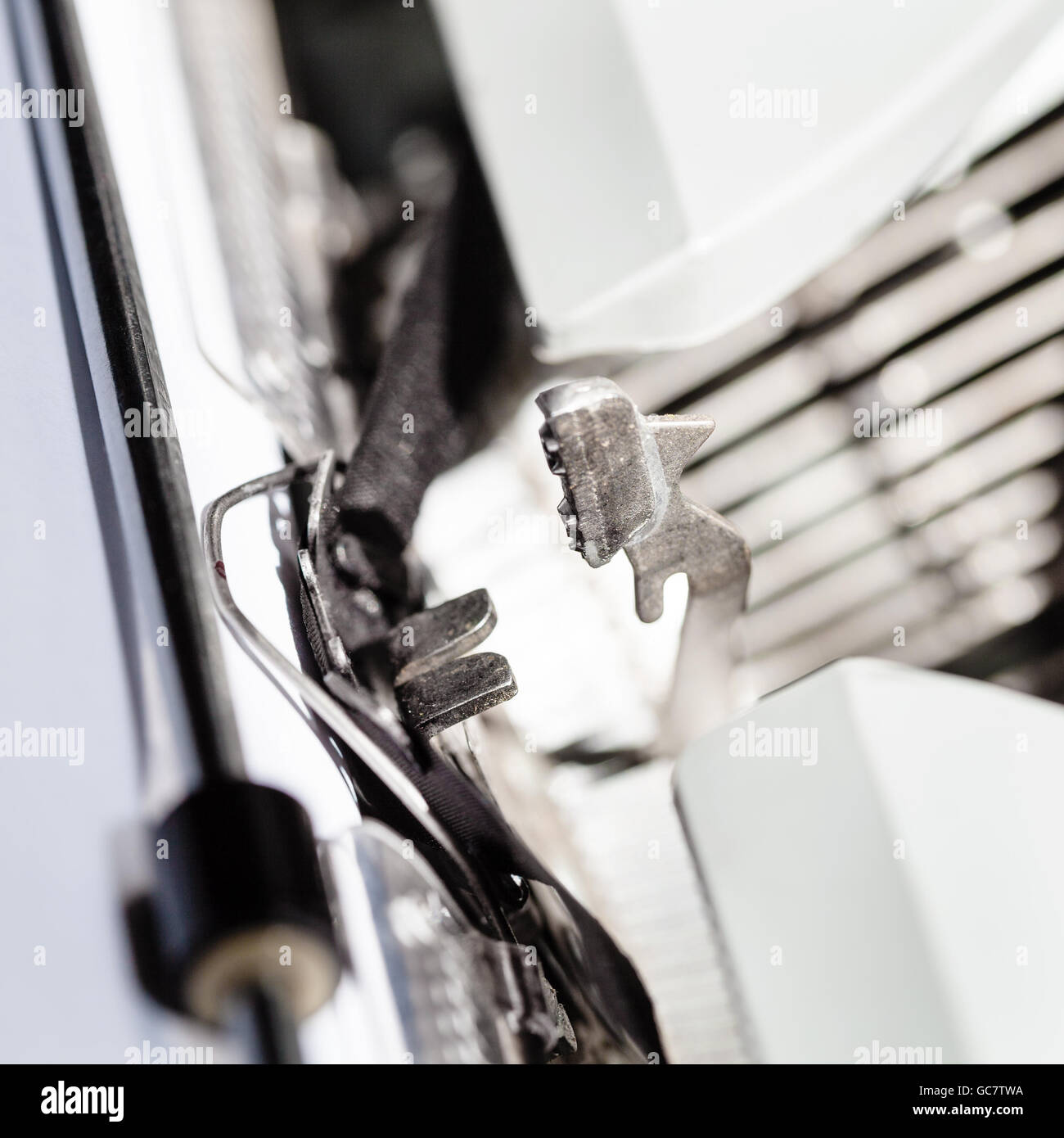 side view of typebar with character operates in old typewriter close up ...