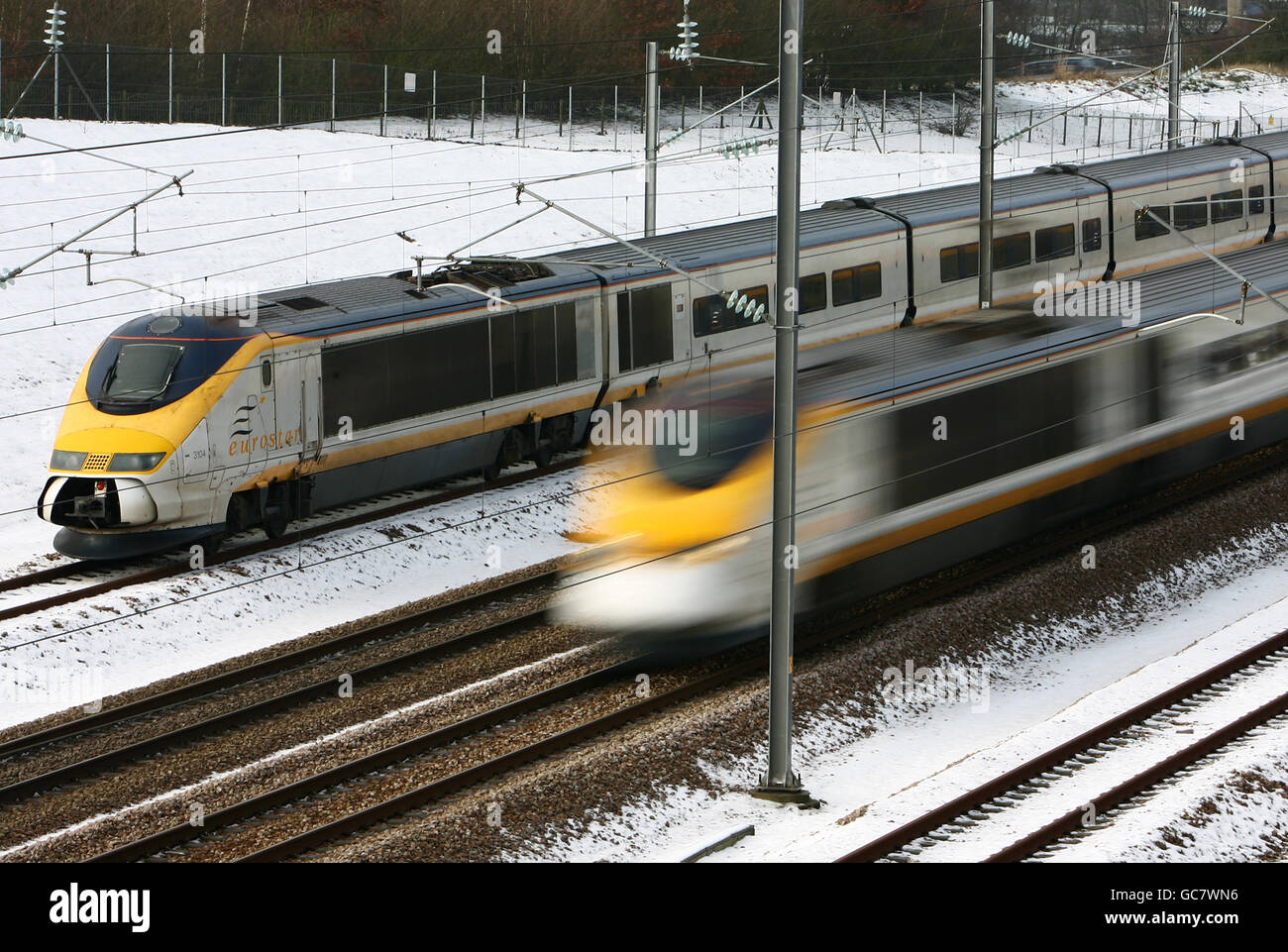 A Eurostar train heading for Europe passes one of the stranded trains ...