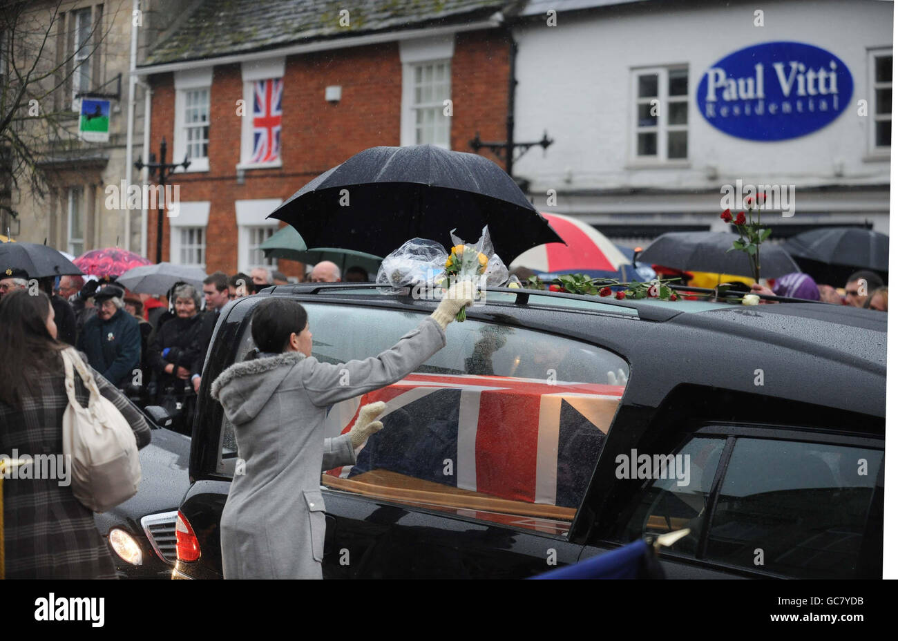 Mourners gather to pay their respects as three hearses containing the ...