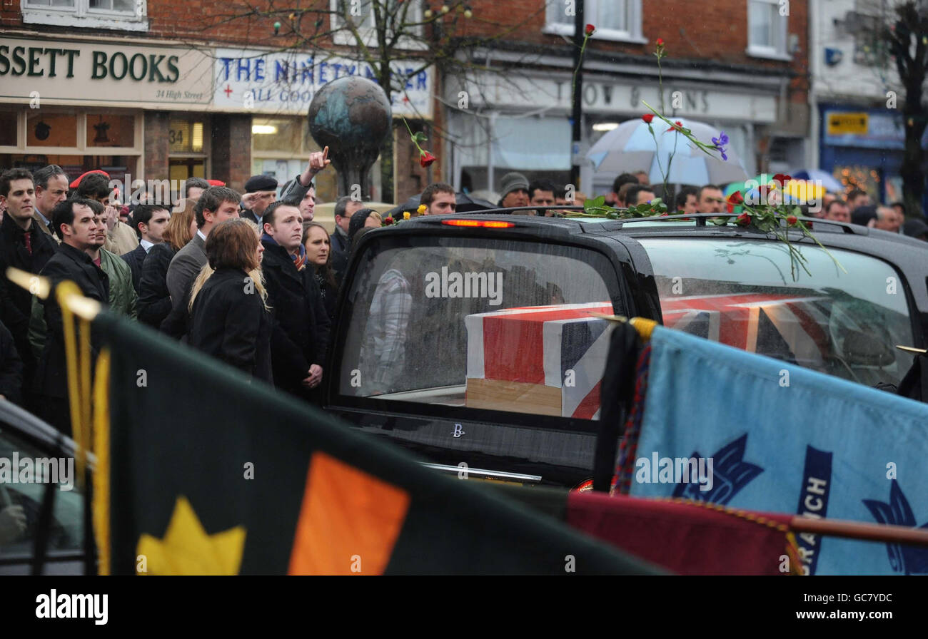 Mourners gather to pay their respects as three hearses containing the ...