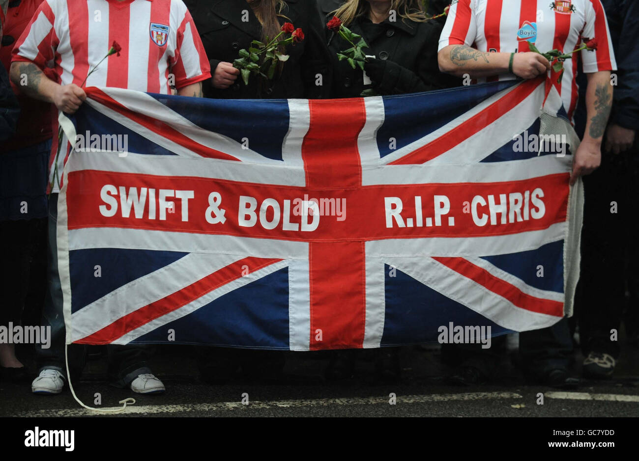 Mourners gather to pay their respects as three hearses containing the ...