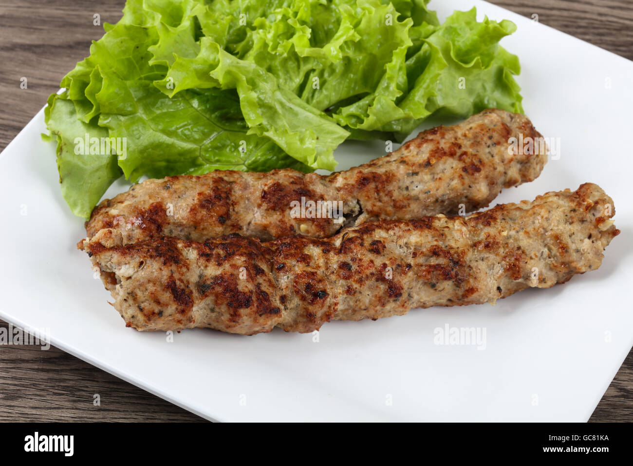 Meat kebab with green salad leaves Stock Photo - Alamy