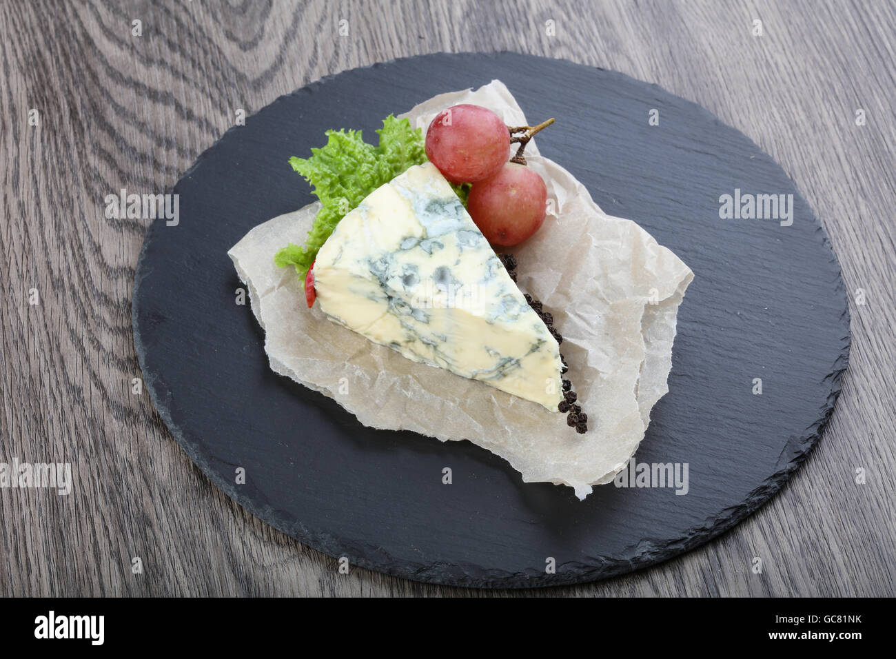 Blue cheese served grape and salad leaves Stock Photo - Alamy