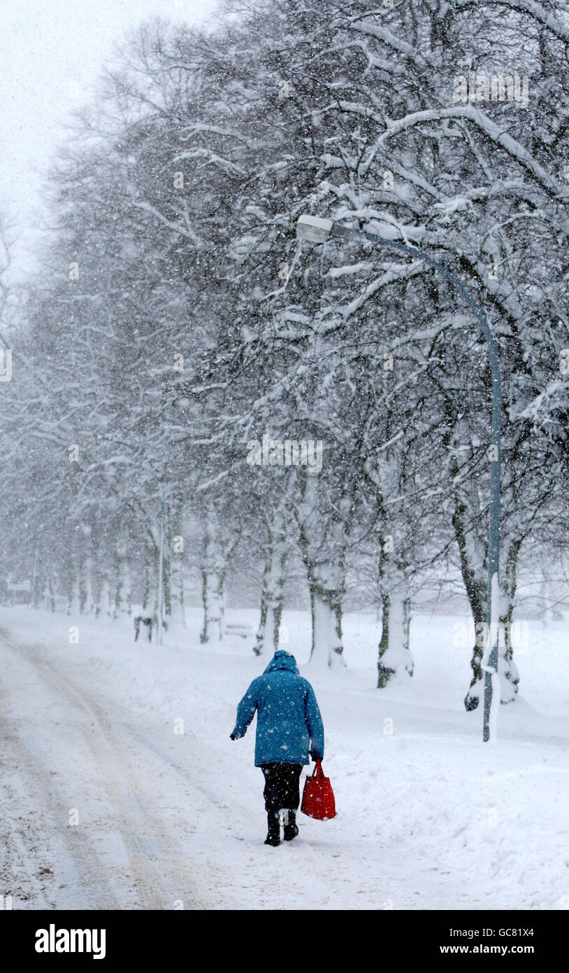 A woman walks through heavy snow in St Boswells in the Scottish Borders Stock Photo - Alamy