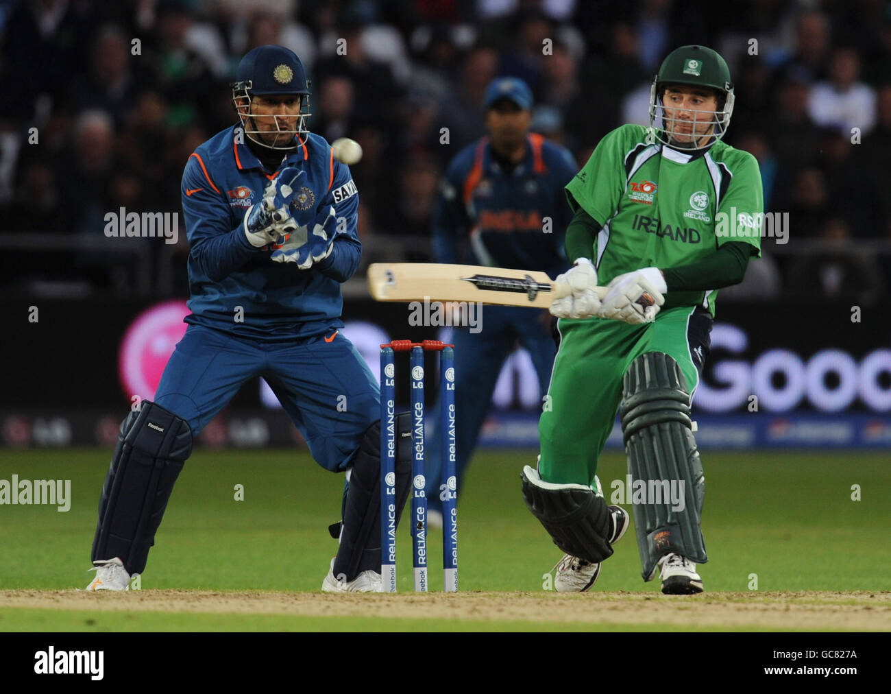 India's wicket-keeper Mahendra Singh Dhoni (left) braces himself as ...