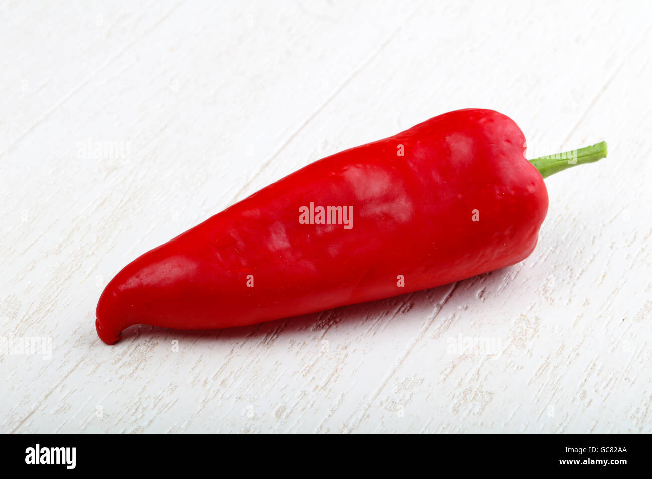 Red romano pepper on the wood background Stock Photo - Alamy