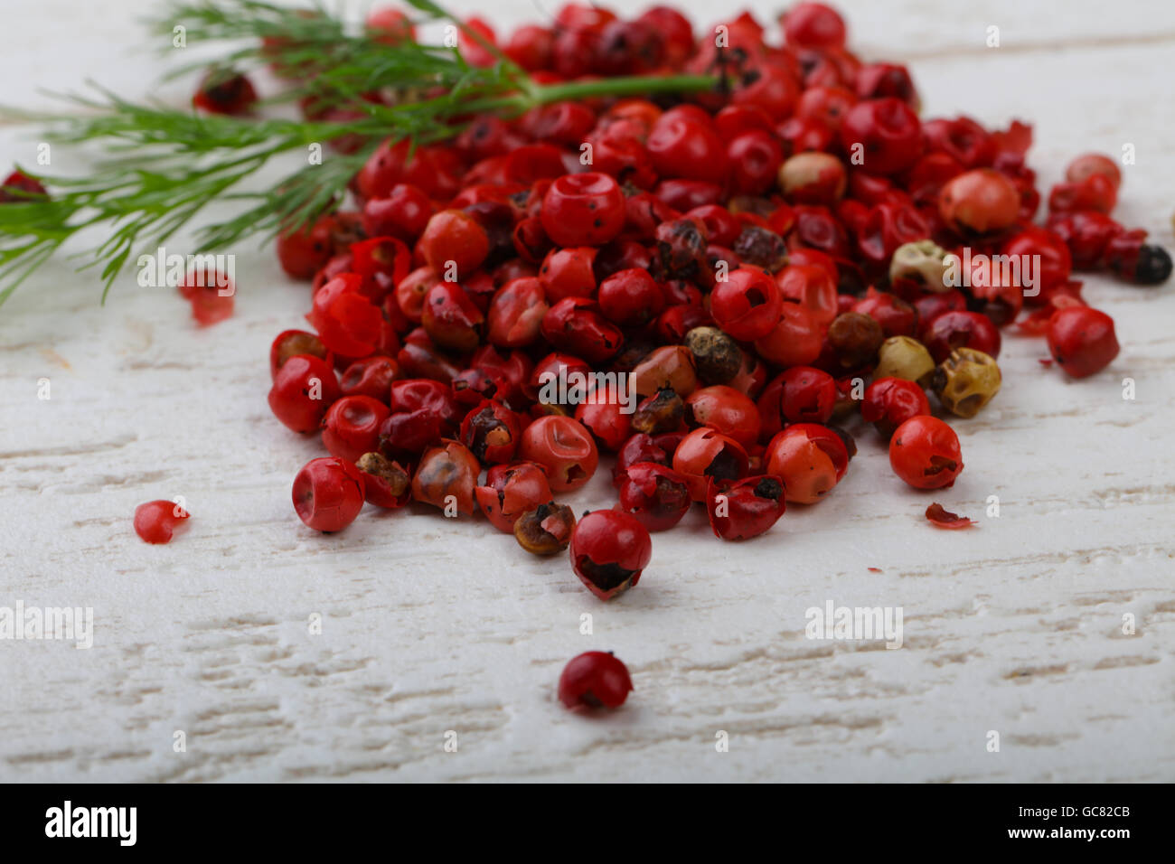 Red pepper corn on the wood background Stock Photo - Alamy