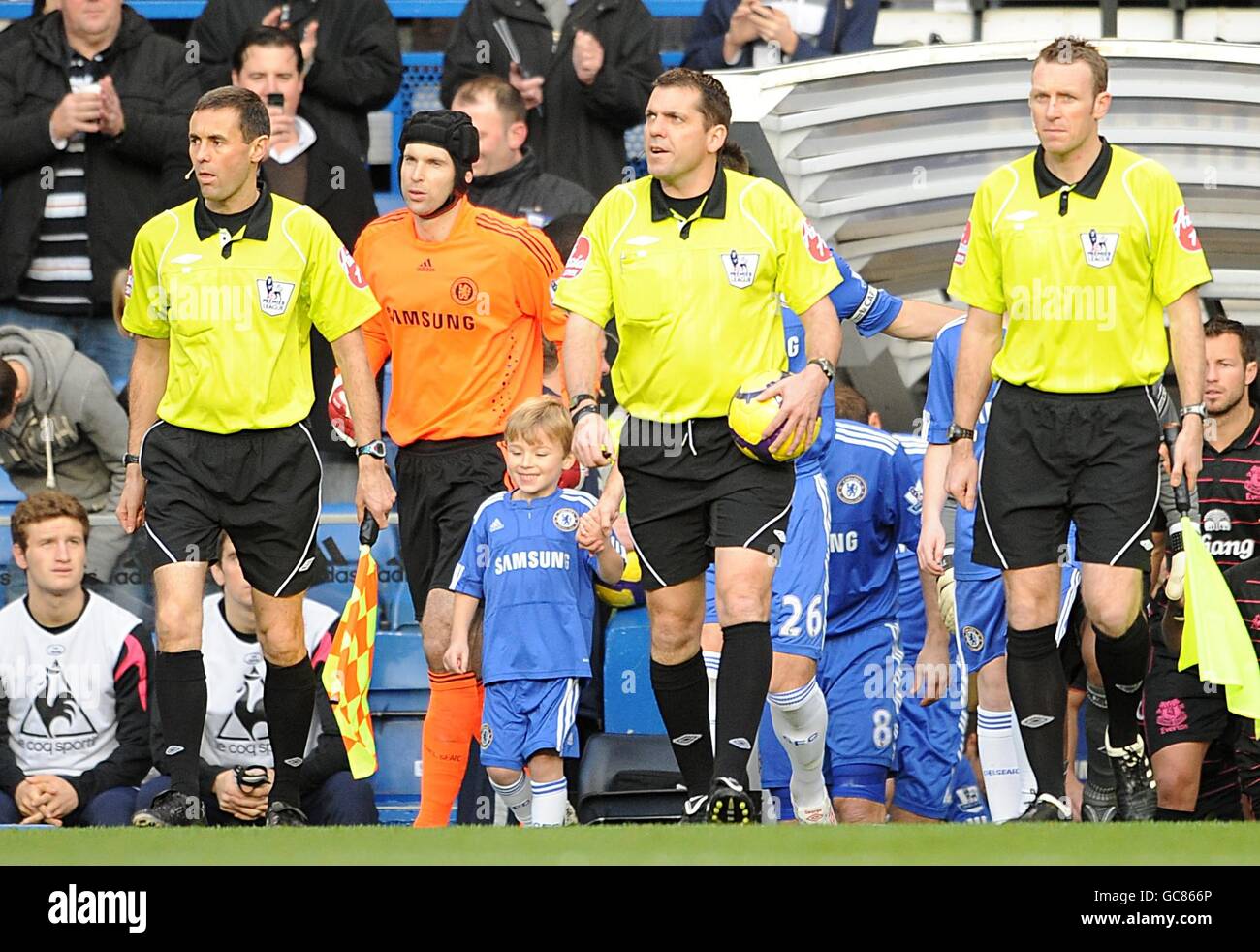 Referee Phil Dowd (centre) leads the players onto the pitch prior to ...