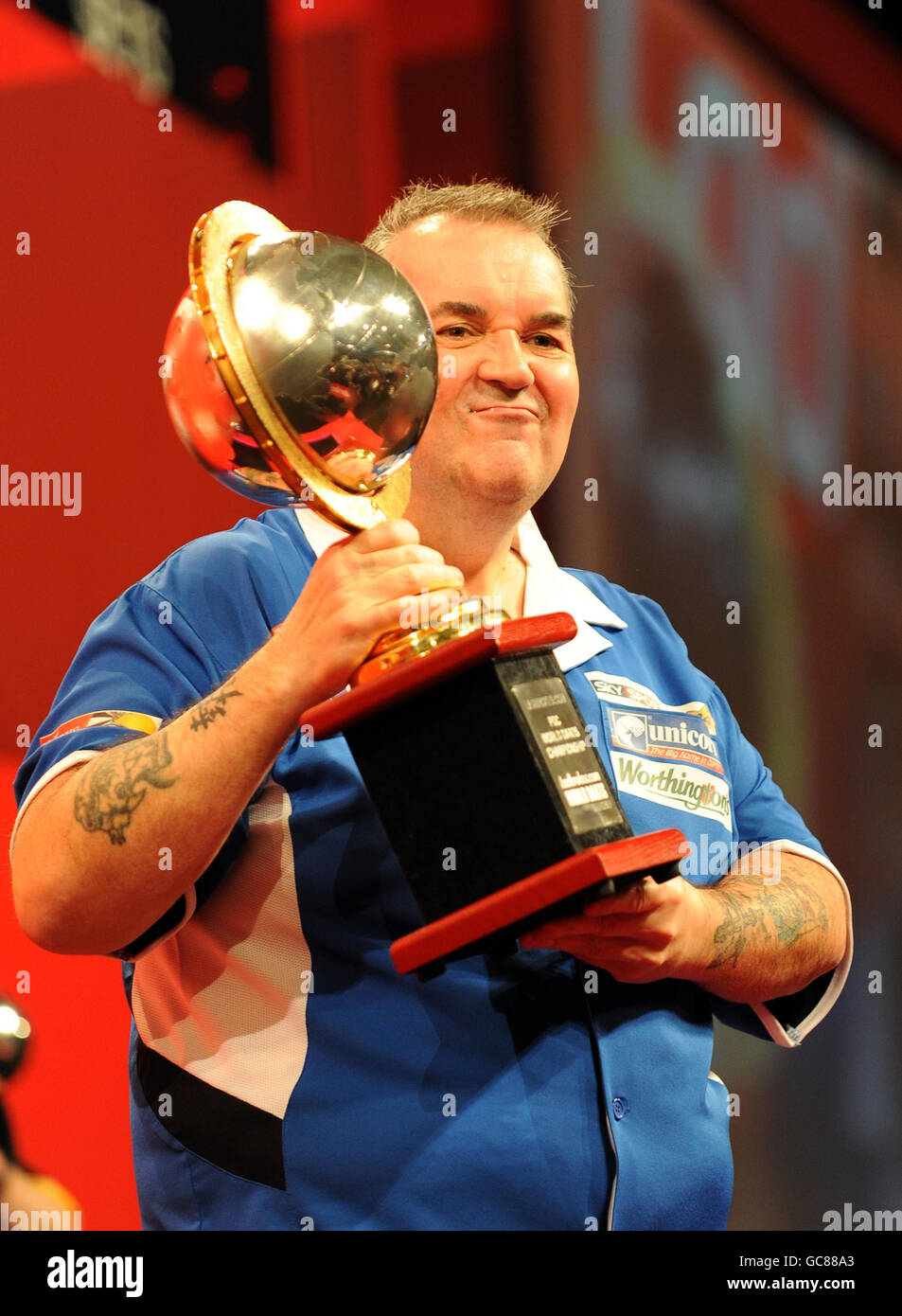 Phil Taylor celebrates with the trophy after his victory over Simon ...