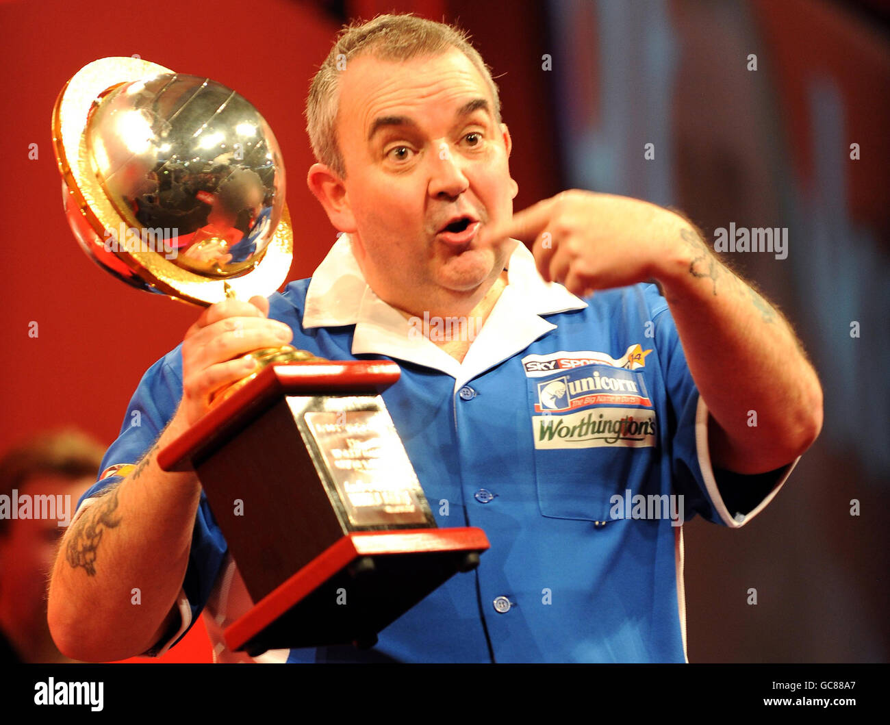 Phil Taylor celebrates with the trophy after his victory over Simon ...
