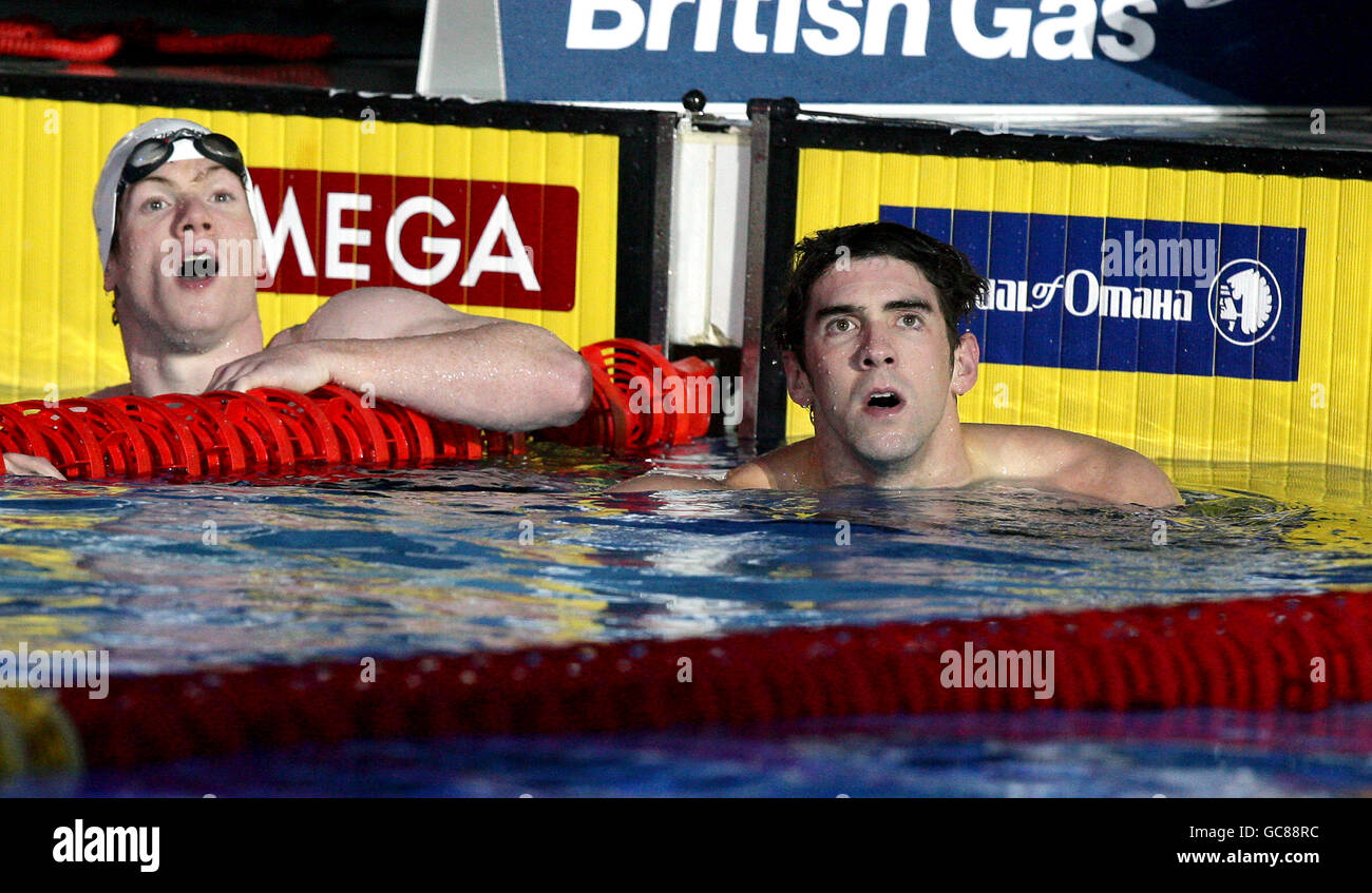 USA's Michael Phelps (right) waits for the results on the big screen ...