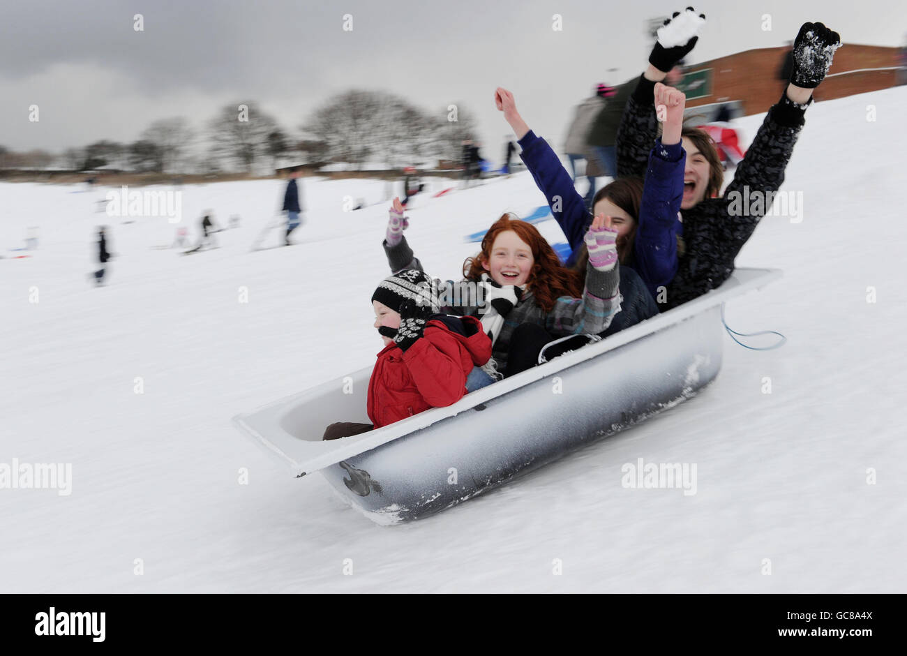 Sledgers use an old bath tub to sledge in Whitley Bay in North Tyneside ...