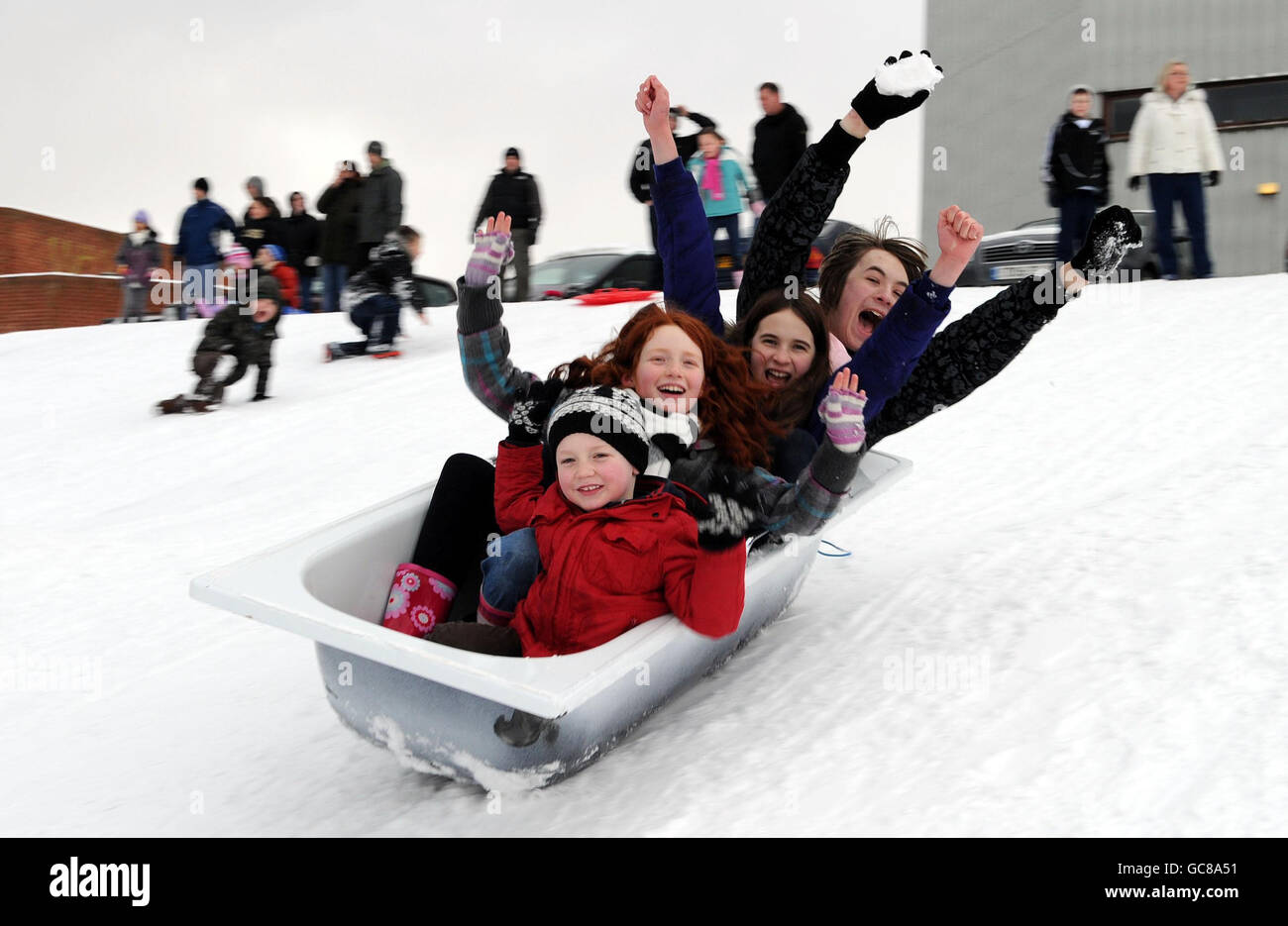 Sledgers use an old bath tub to sledge in Whitley Bay in North Tyneside ...