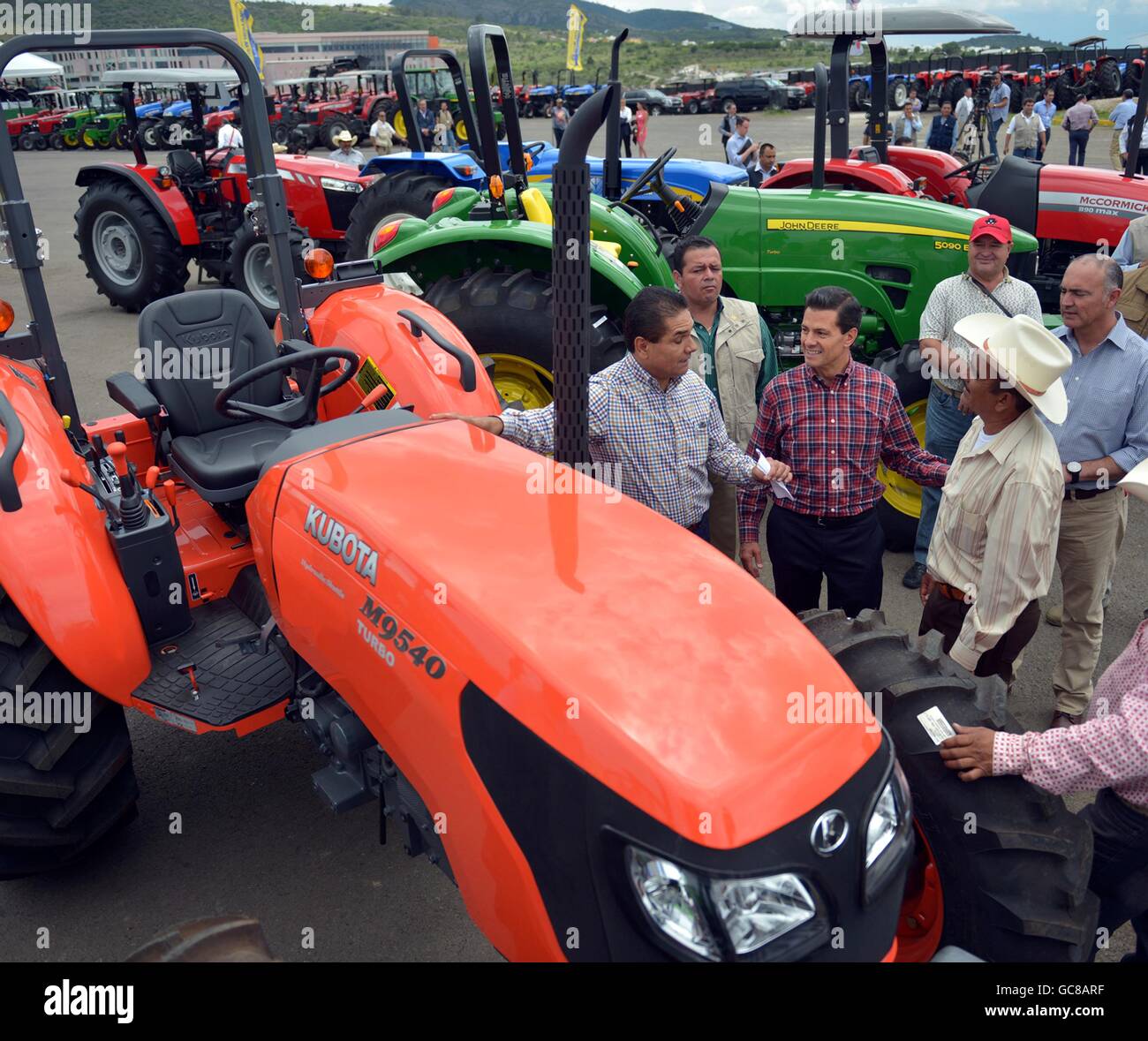 Mexican President Enrique Pena Nieto, center, is shown a Kubota tractor ...